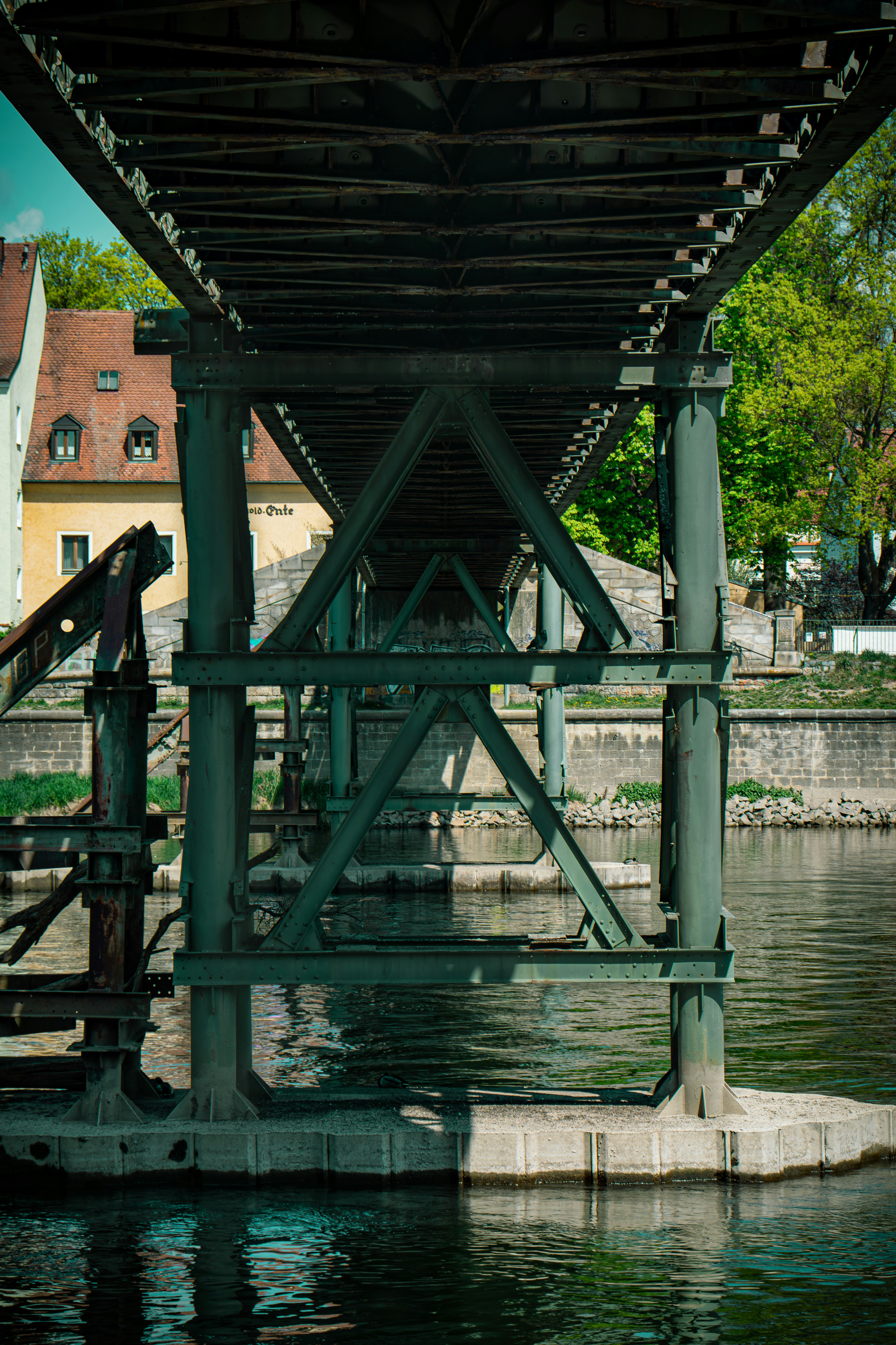 Under the Iron Spine: A Riverside Ironwork Corridor