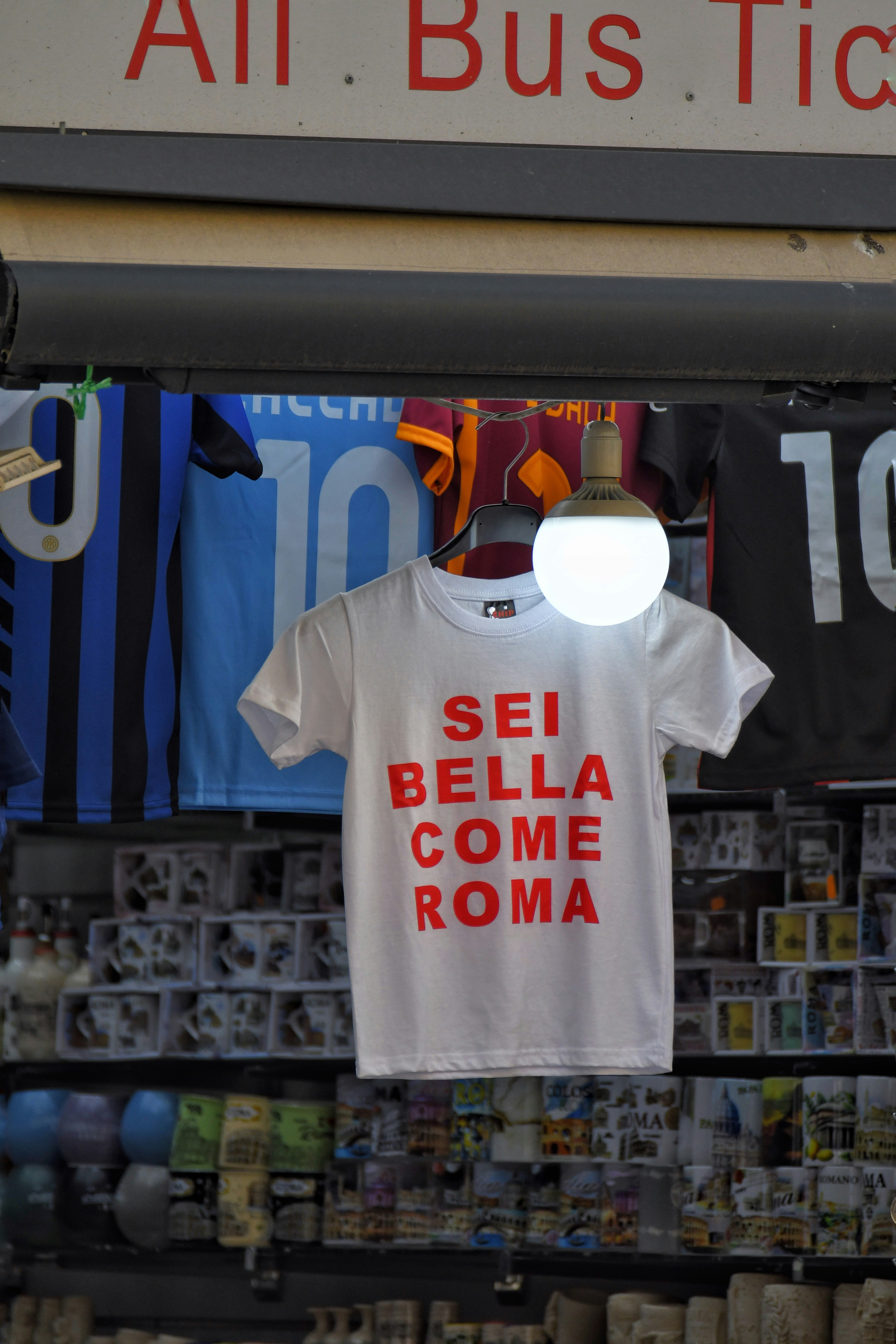 White Tee with Red Frame: Bella Roma at a Busy Market Stall
