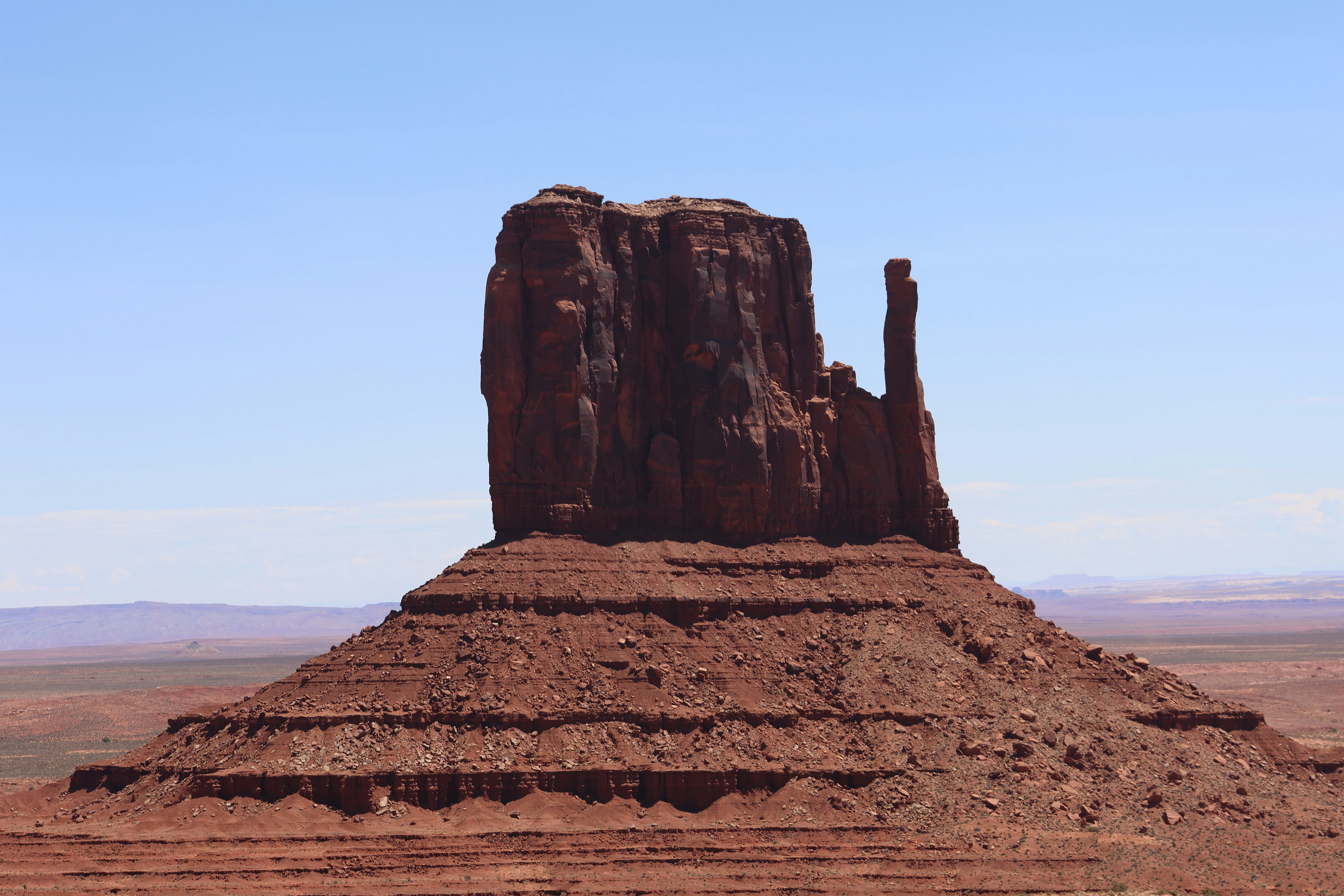 Monolithic Red Rock Sentinel Rising from Desert Terraces