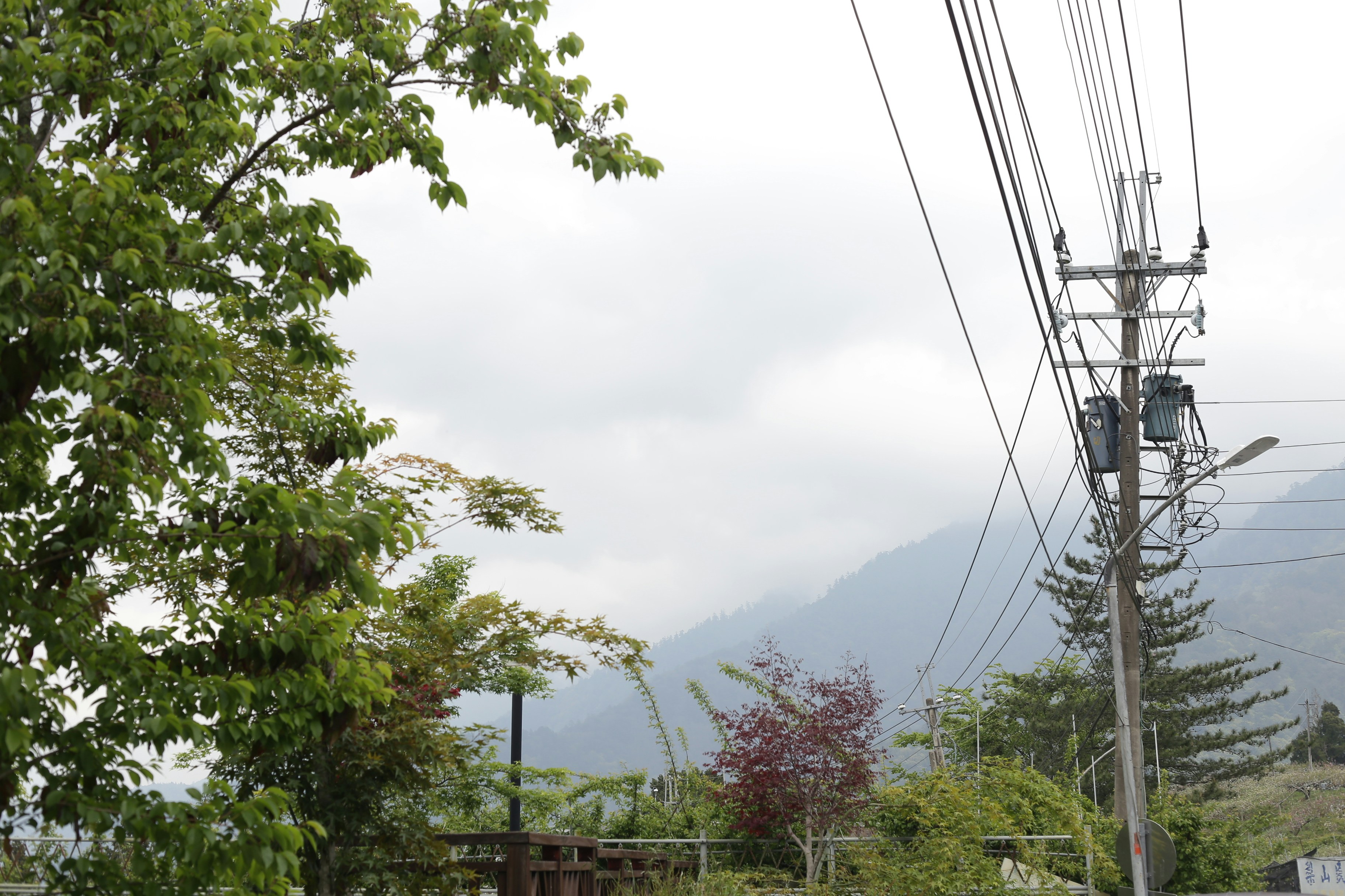 Power Lines Against a Quiet Mountain Backdrop