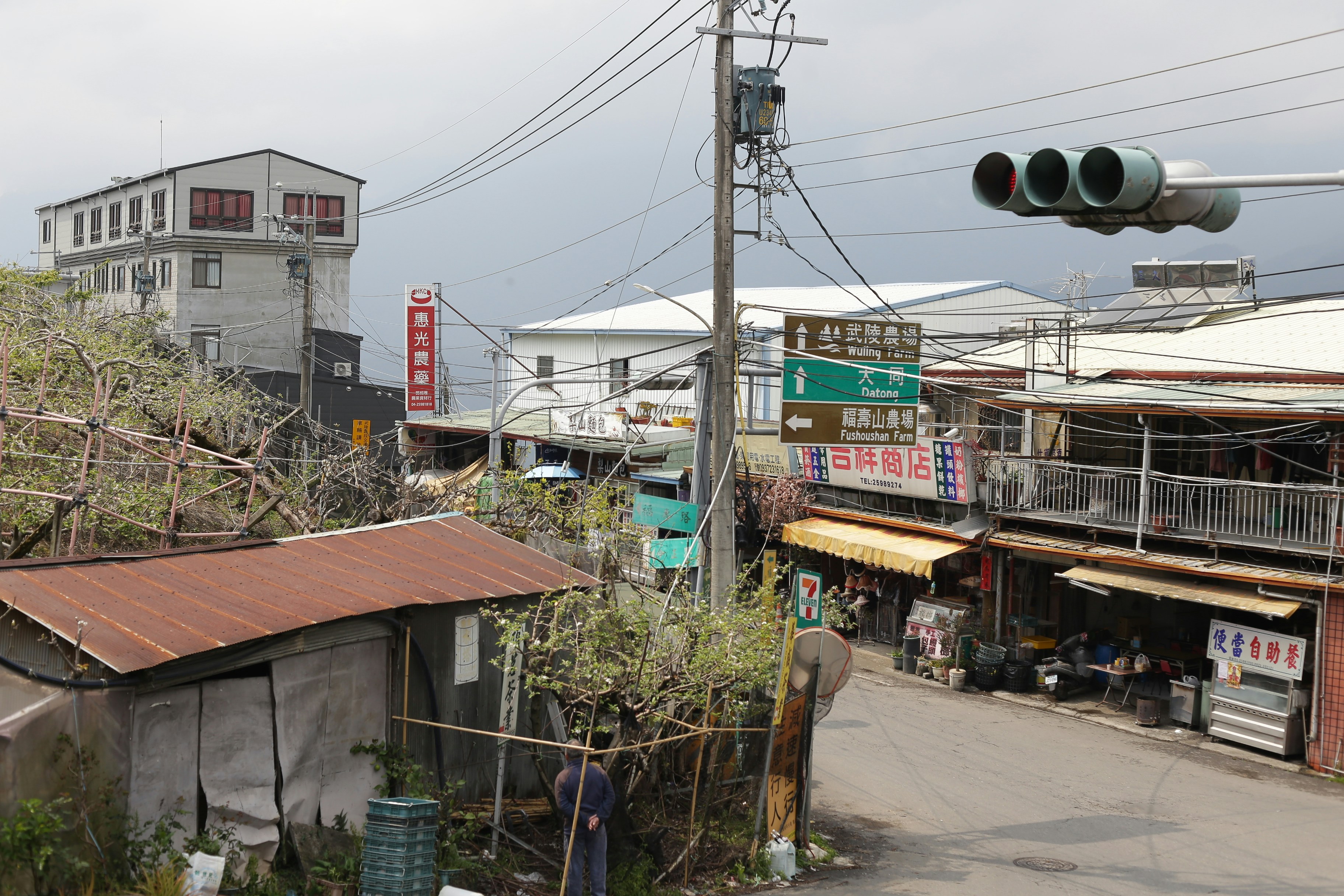 Rural Town Crossroads Under a Tangle of Wires