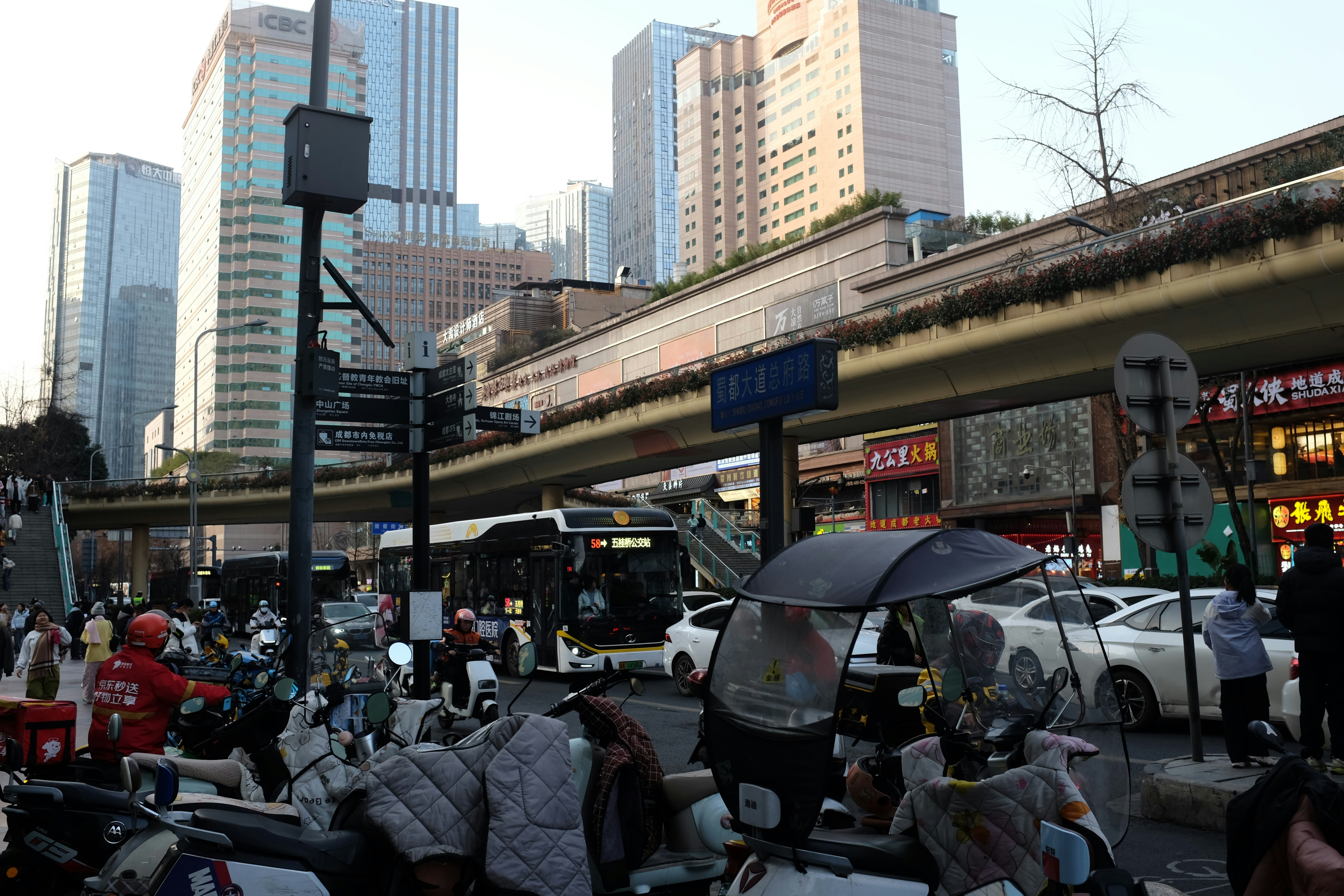 City Pulse at Street Level: A Tangle of Scooters, Cars, and Skyscrapers
