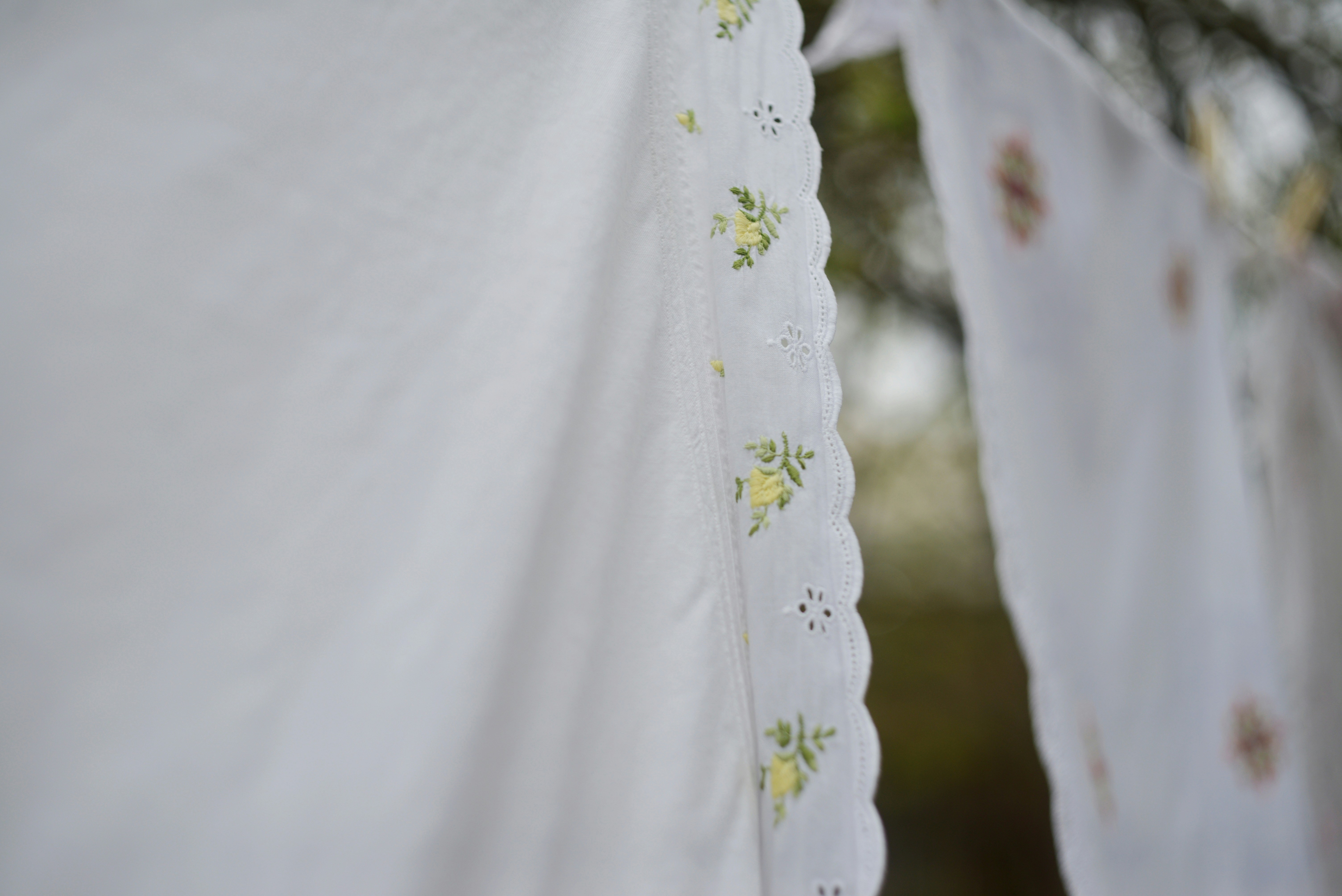 Frayed lace and sunlight: a close-up drift through white linens