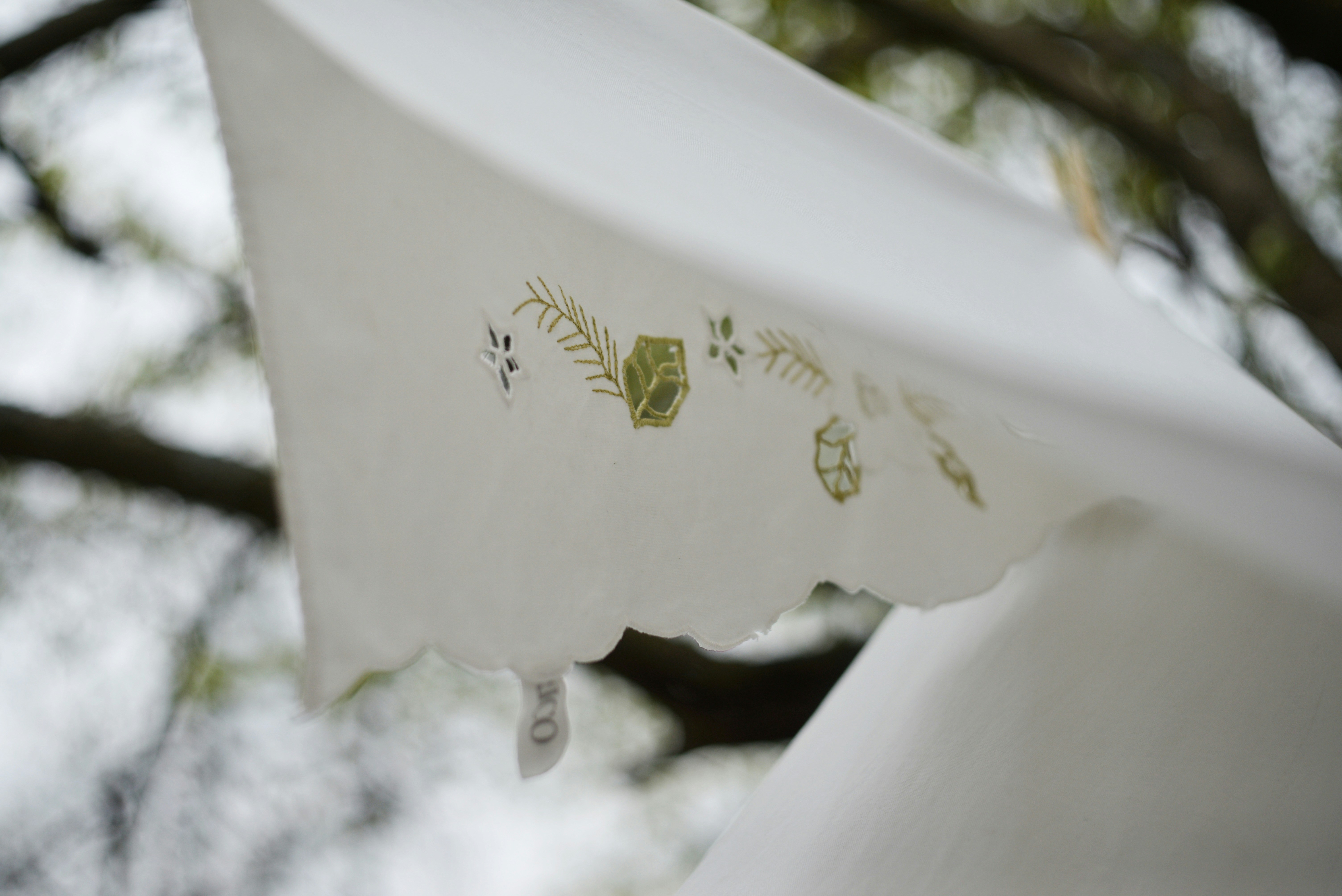 Embroidery and Draped White Cloth: Quiet Details in Soft Focus