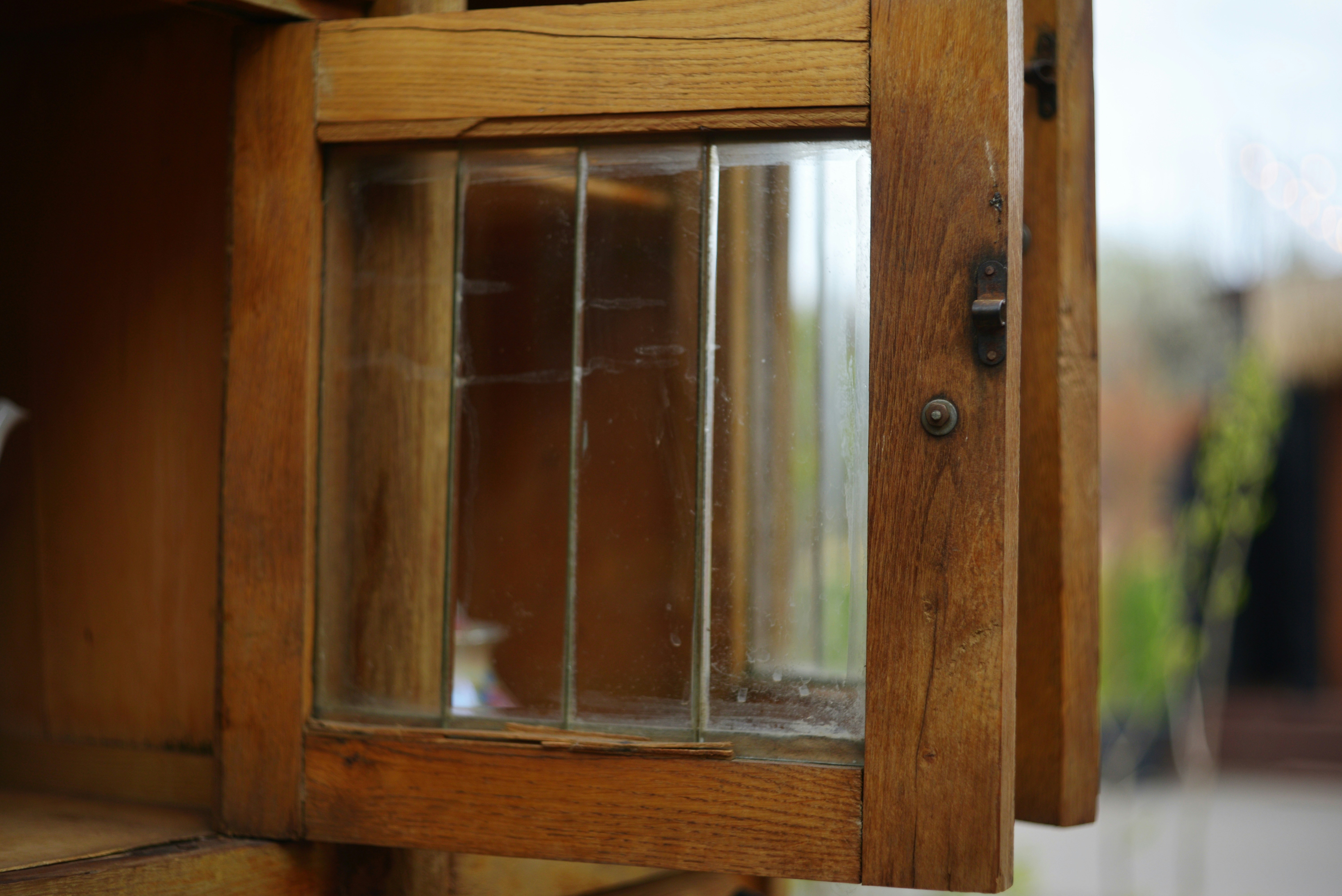 Wooden Window Wedge: a close-up of a rustic panel with glass panes