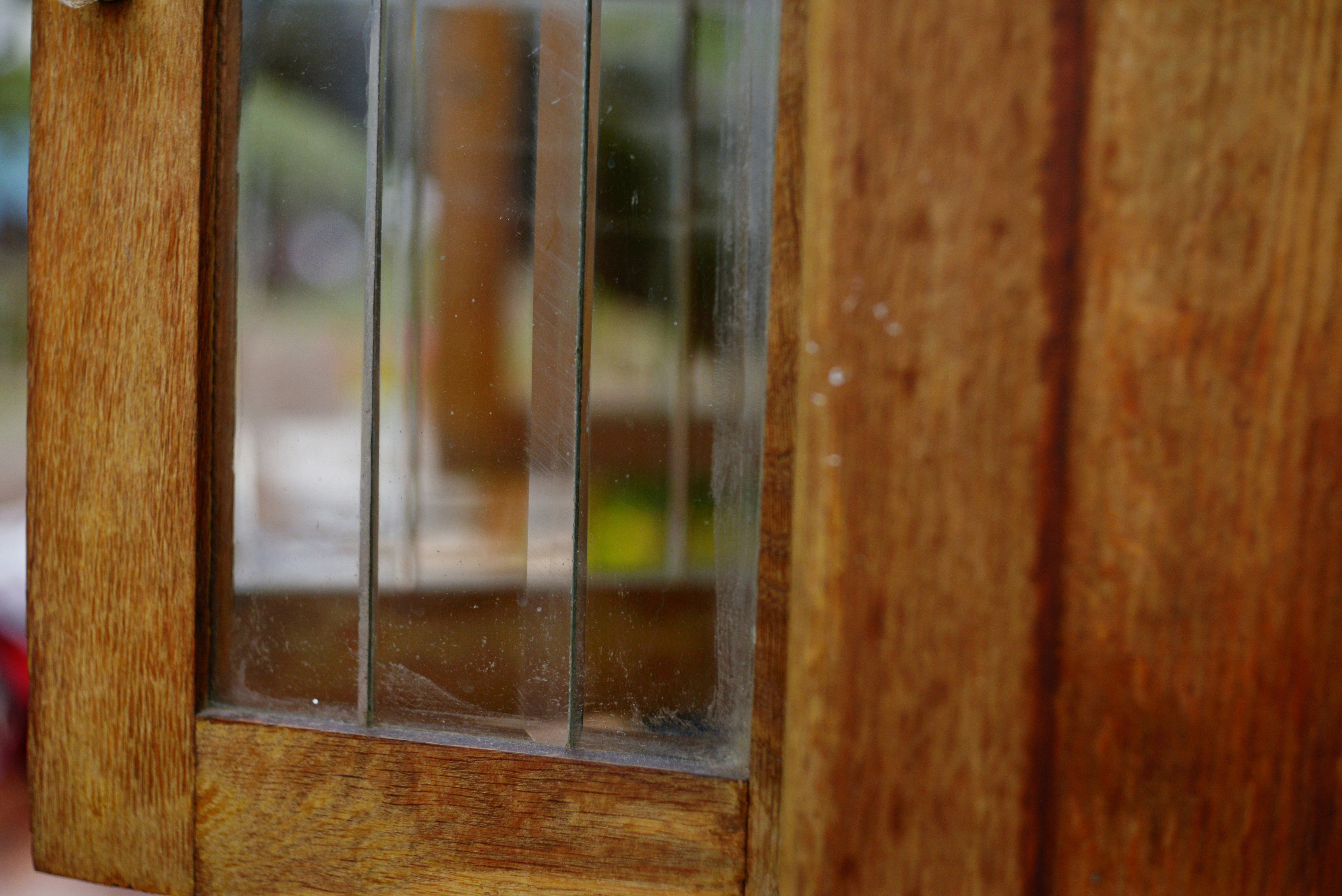 Windowed Glimmer in a Weathered Wooden Frame