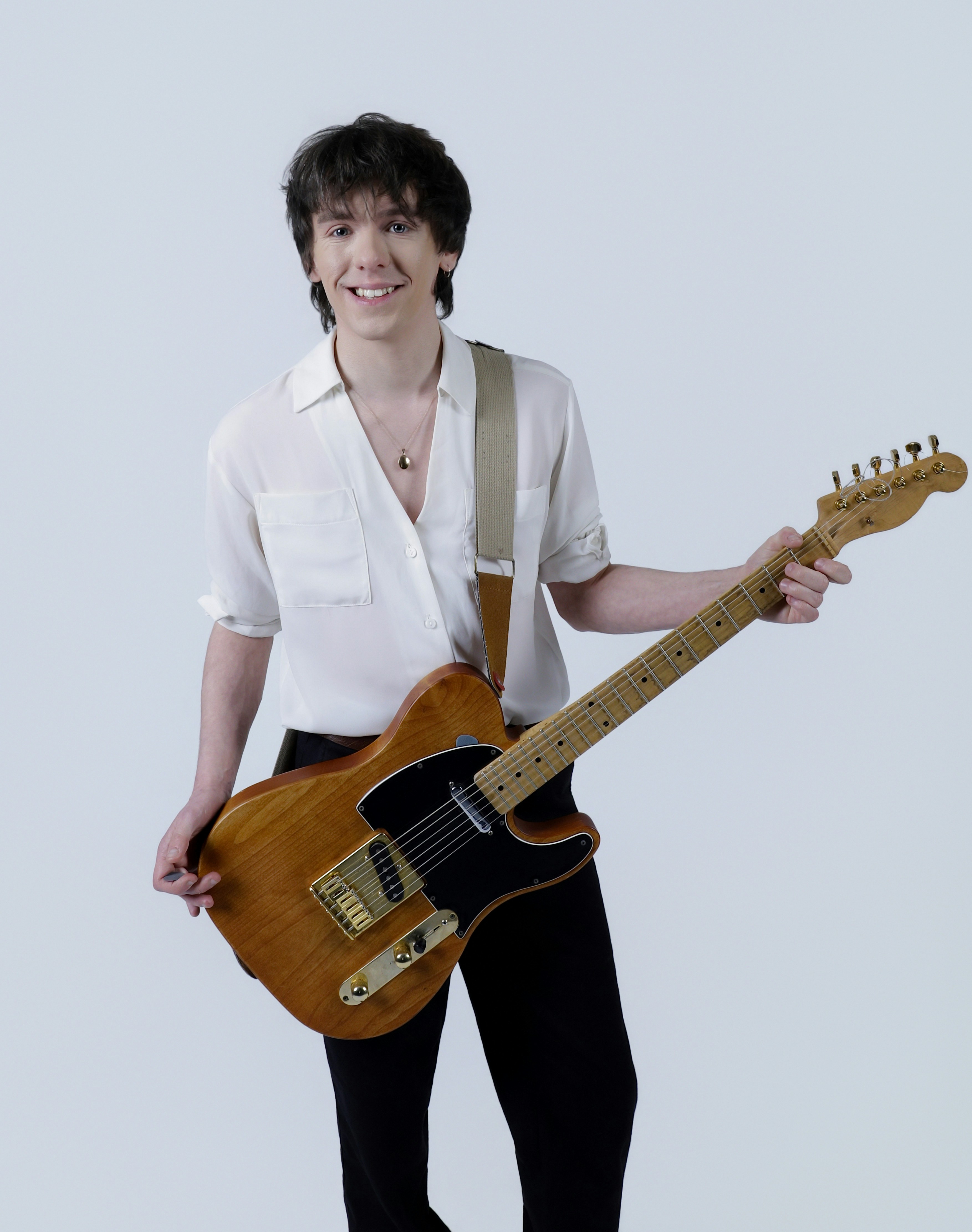 Stage Smile: A Young Guitarist with a Rustic Tele in Hand