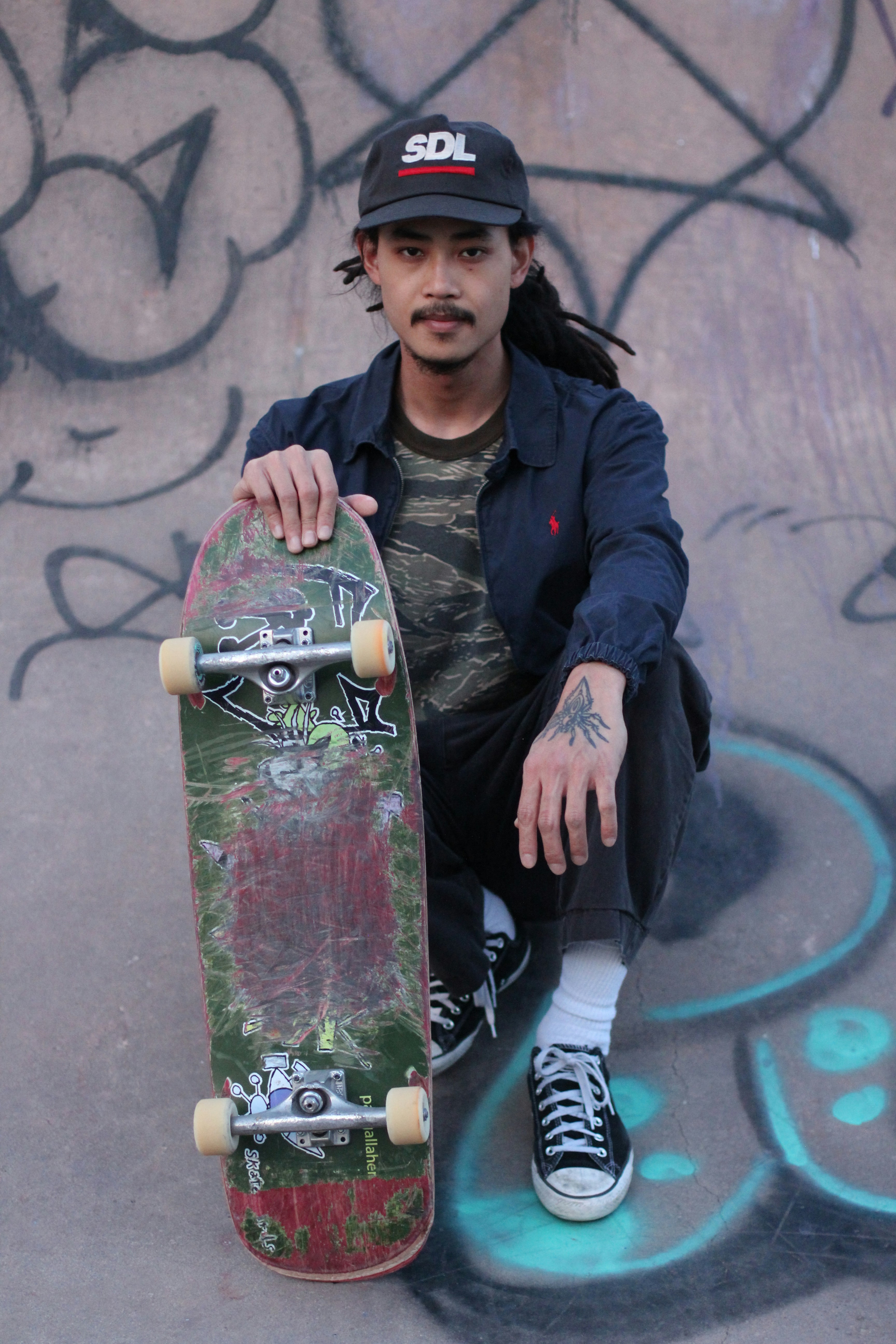 Skater Portrait: Quiet Confidence in Graffiti Light