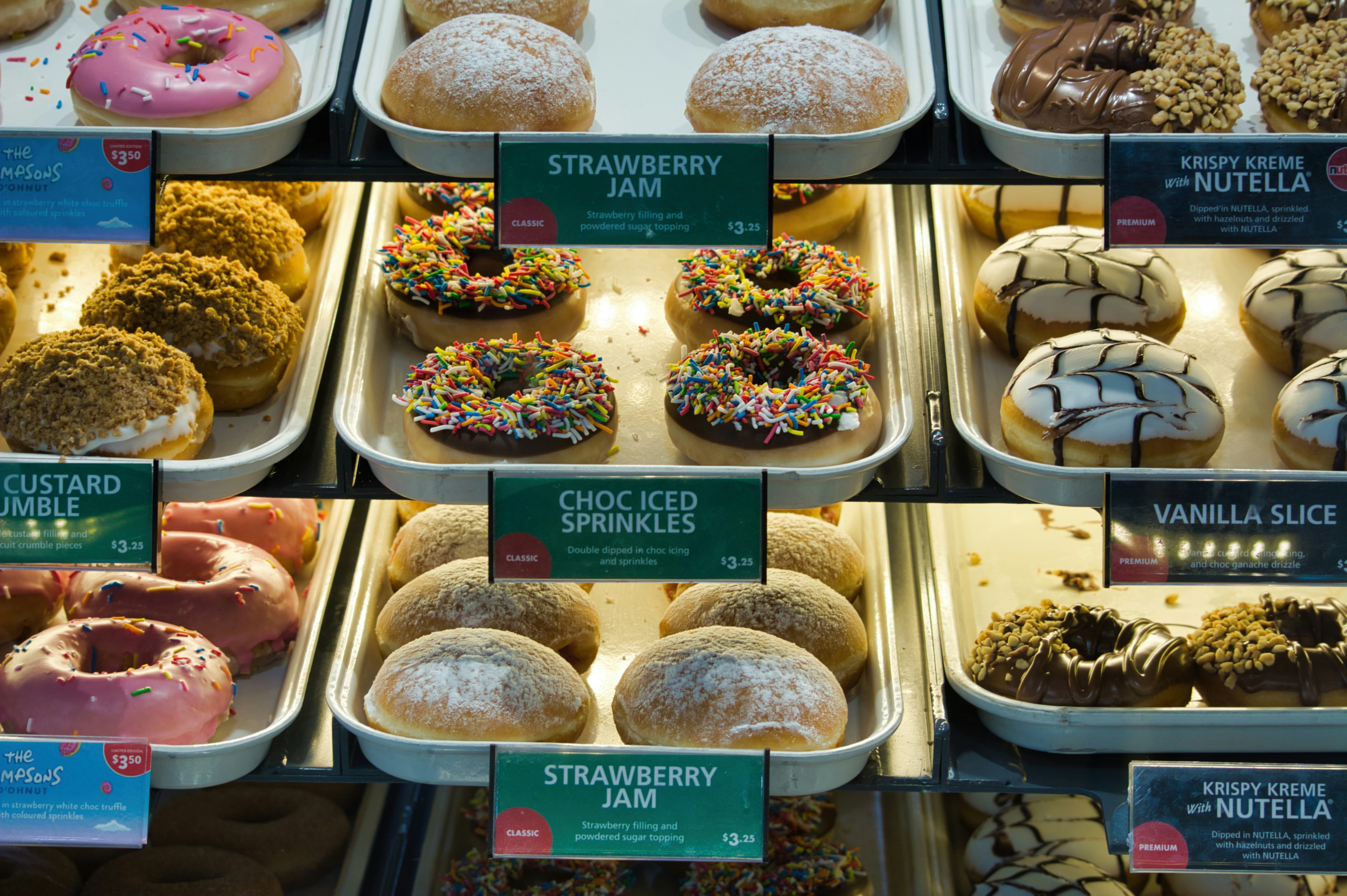Colorful Donut Display: A Glass-Front Bakery Bounty