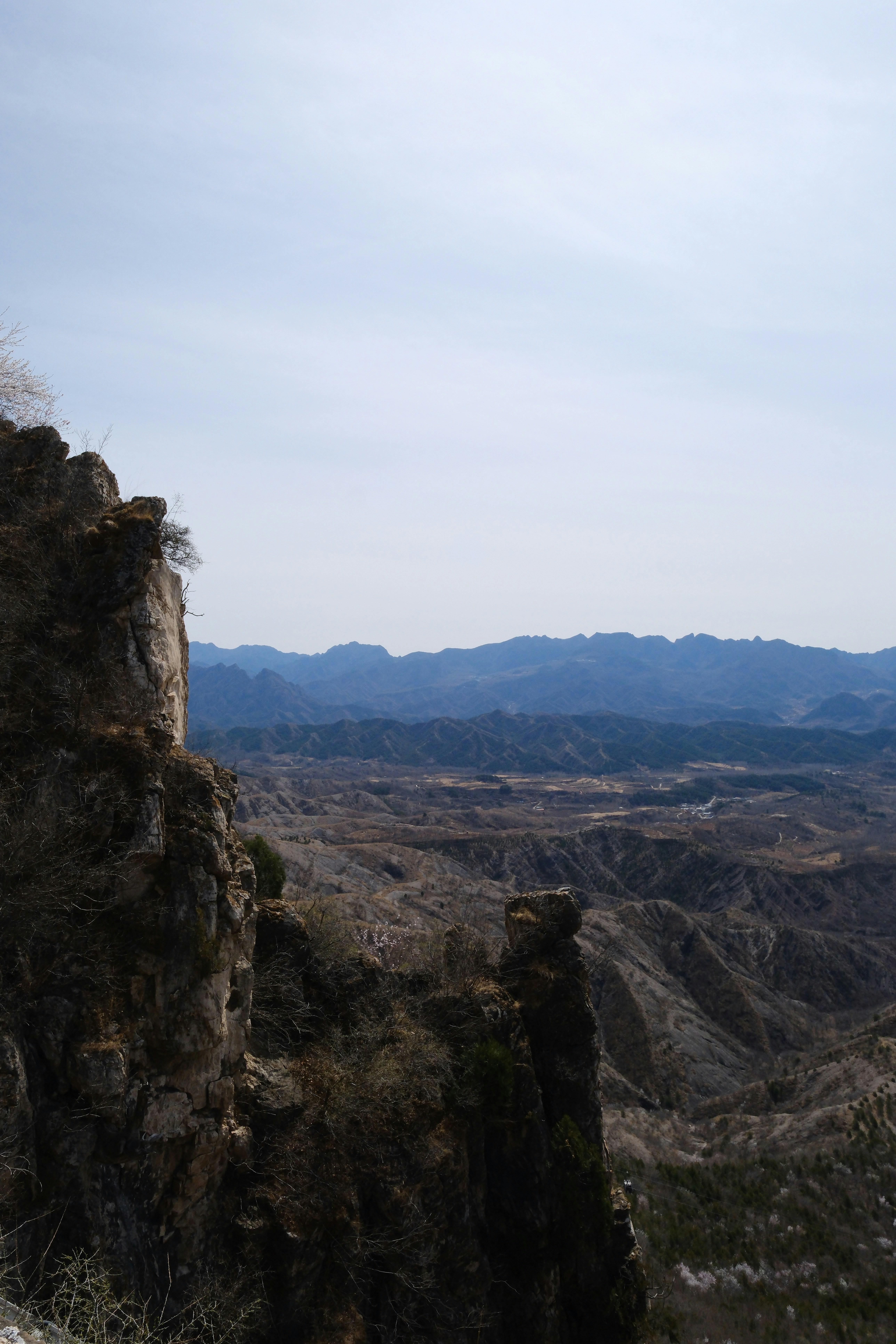 Rugged Dawn: A Cliff Edge Overlooking a Valley of Stone