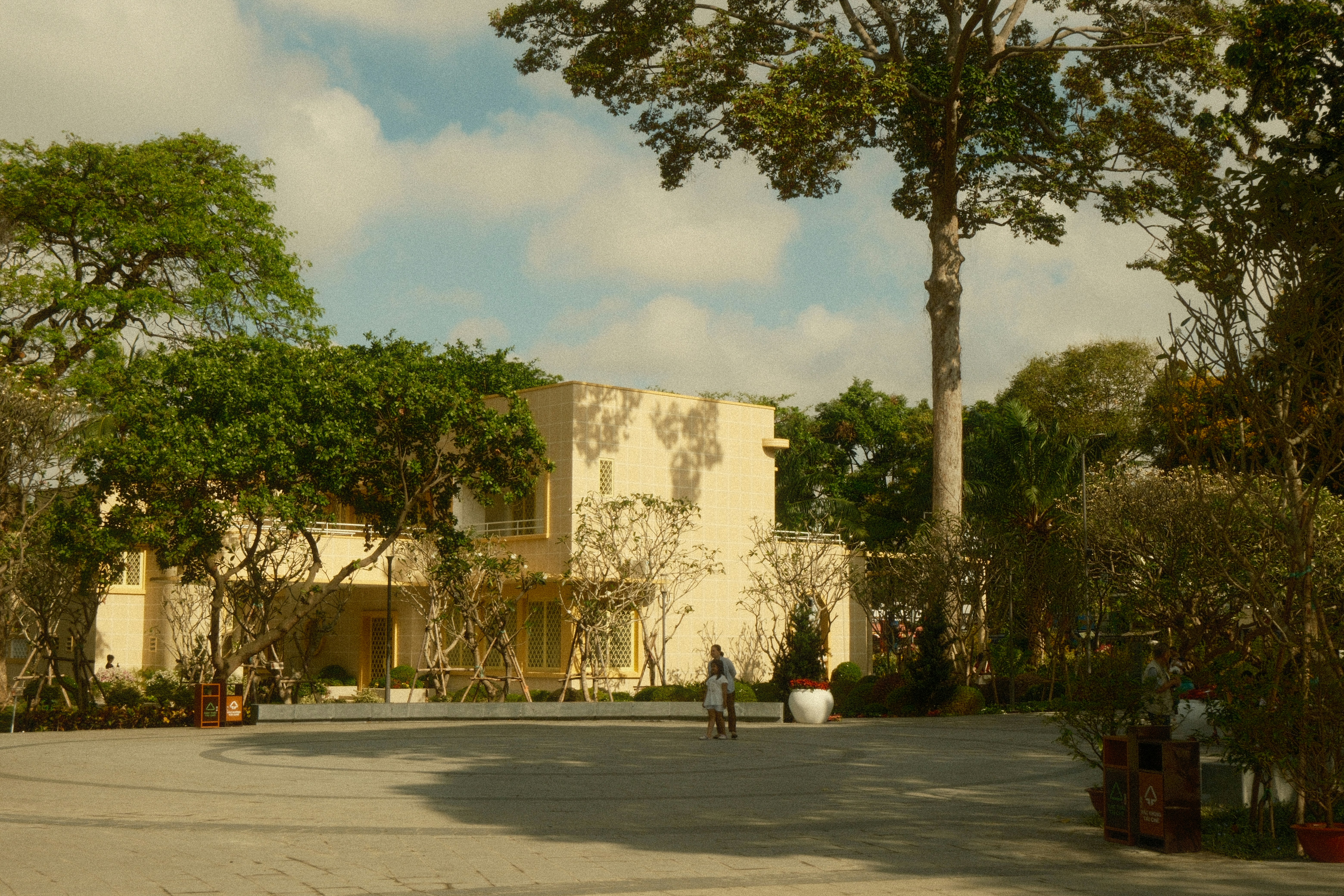 A building surrounded by lush green trees and plants.