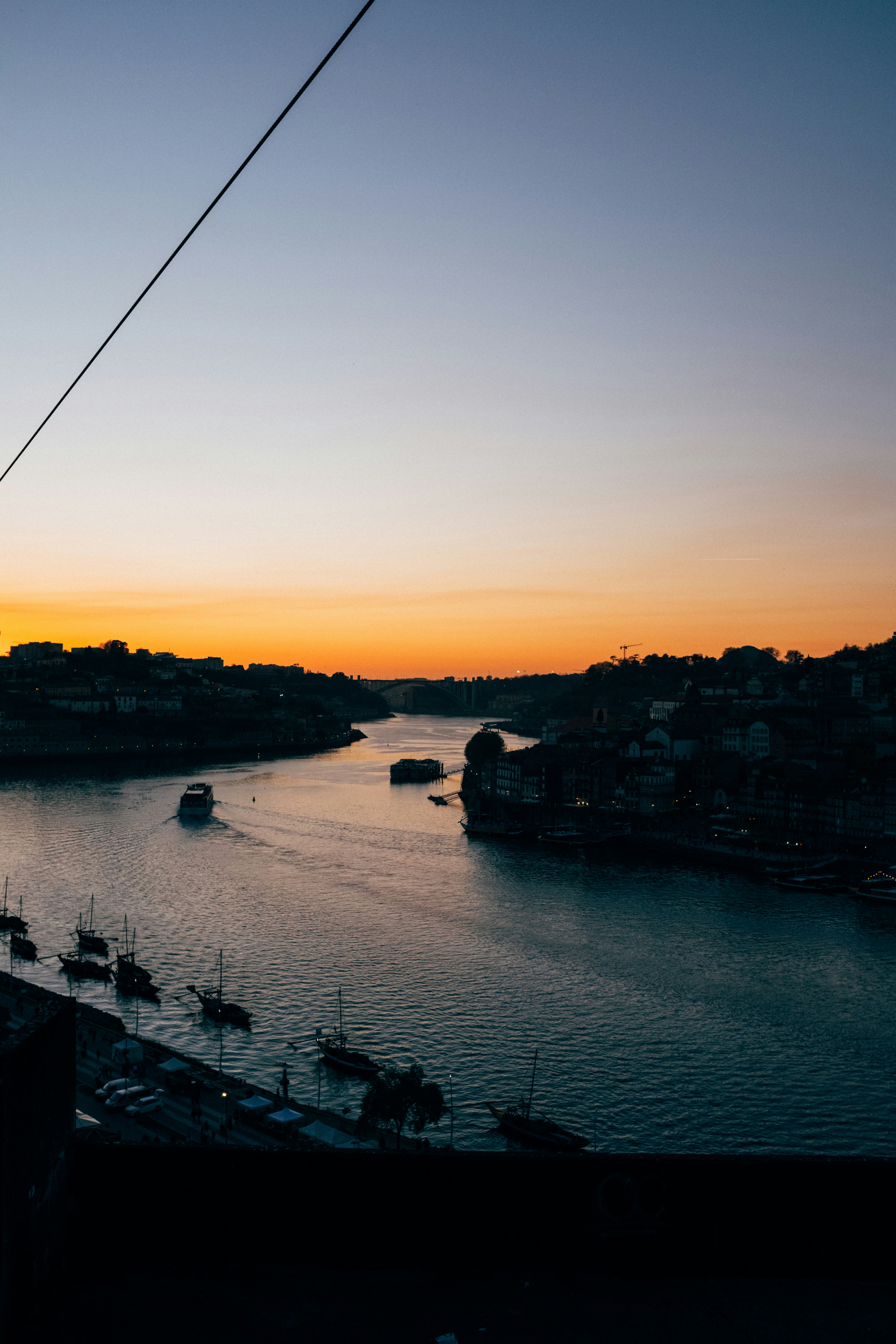 Sunset Quiet over the Douro: Boats Slide Homeward Through Dusk