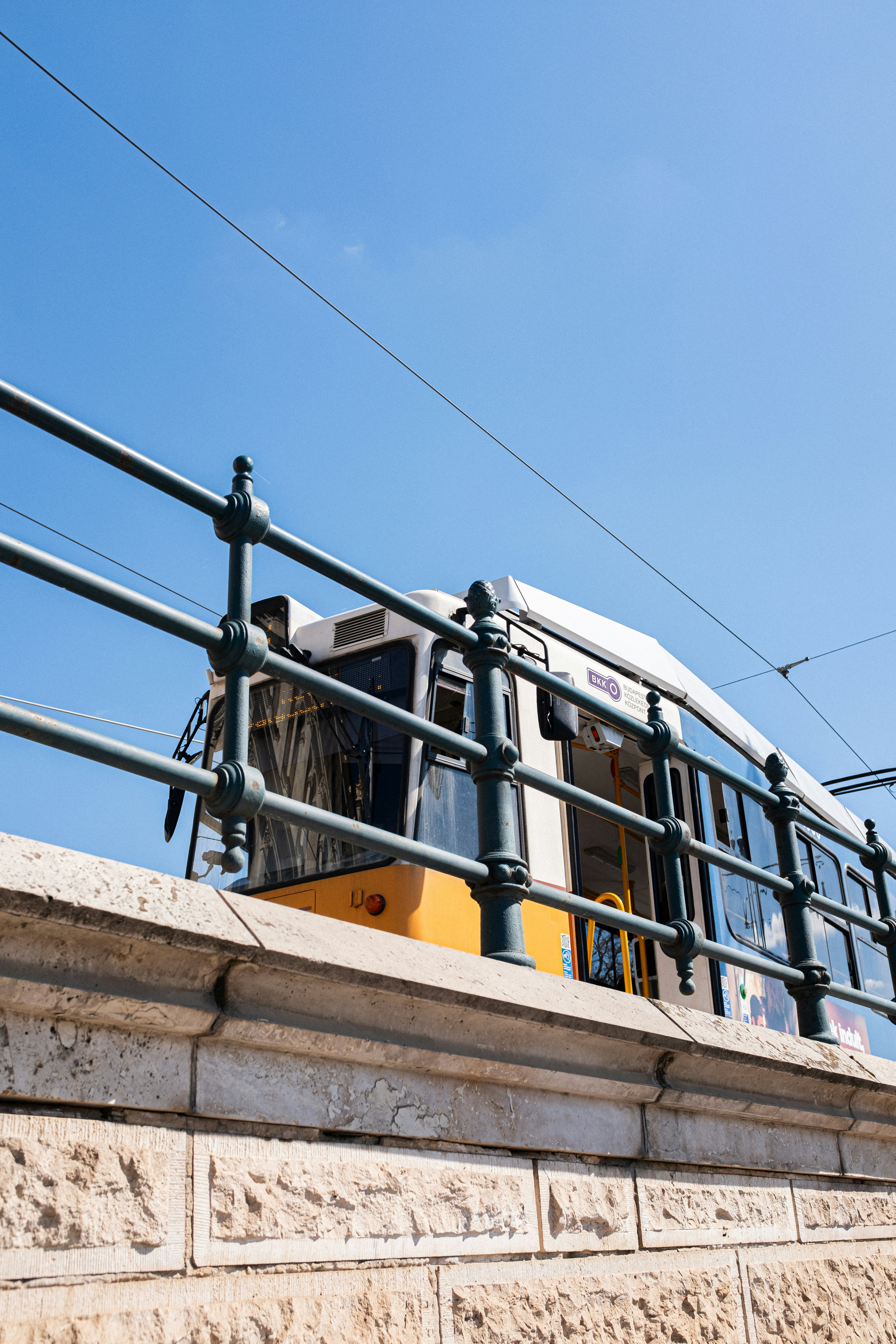 Train Edges Over City Stone: Rails Framed Against a Clear Sky