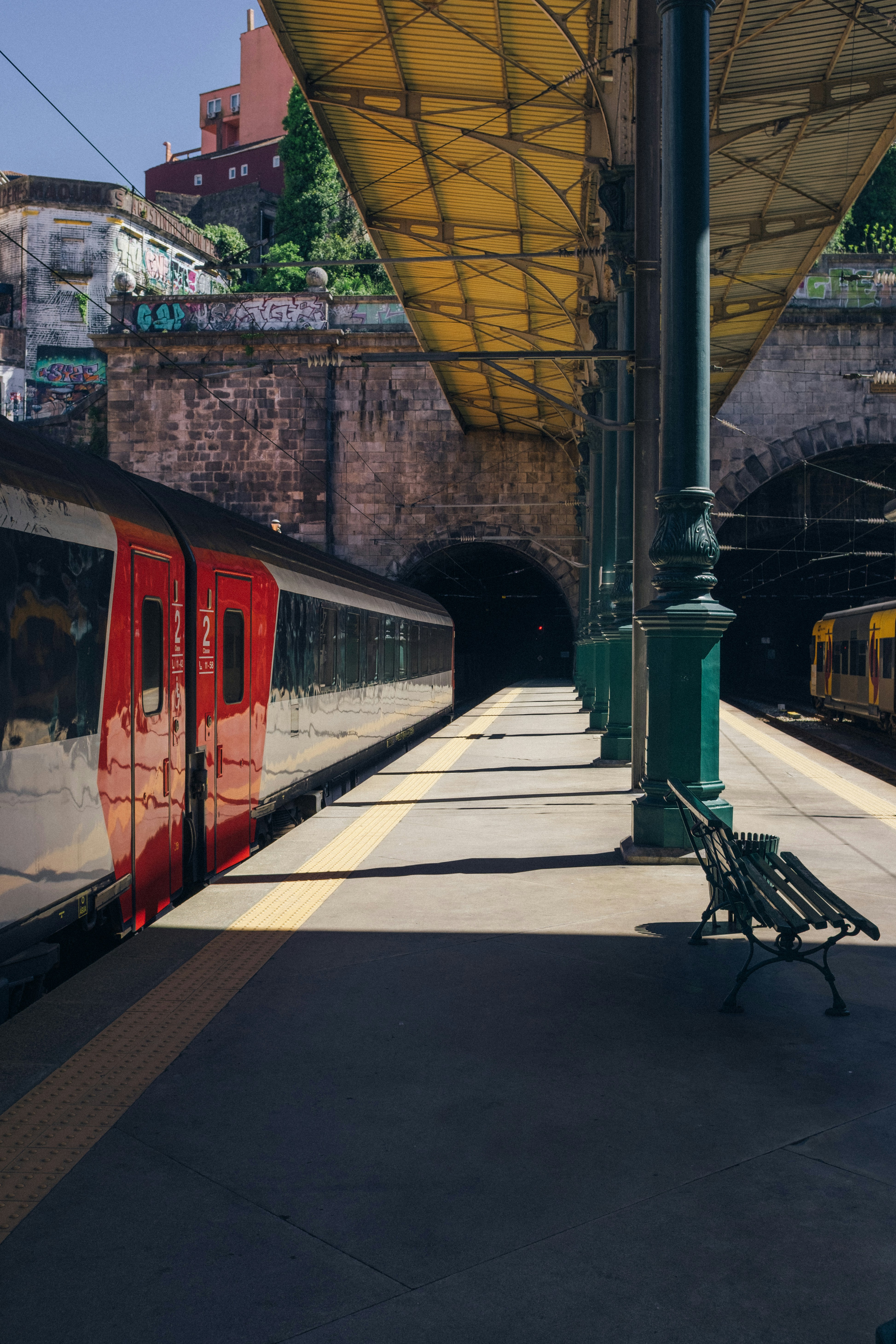 Platform Pulse: Red Carriages and the Tunnel Gaze