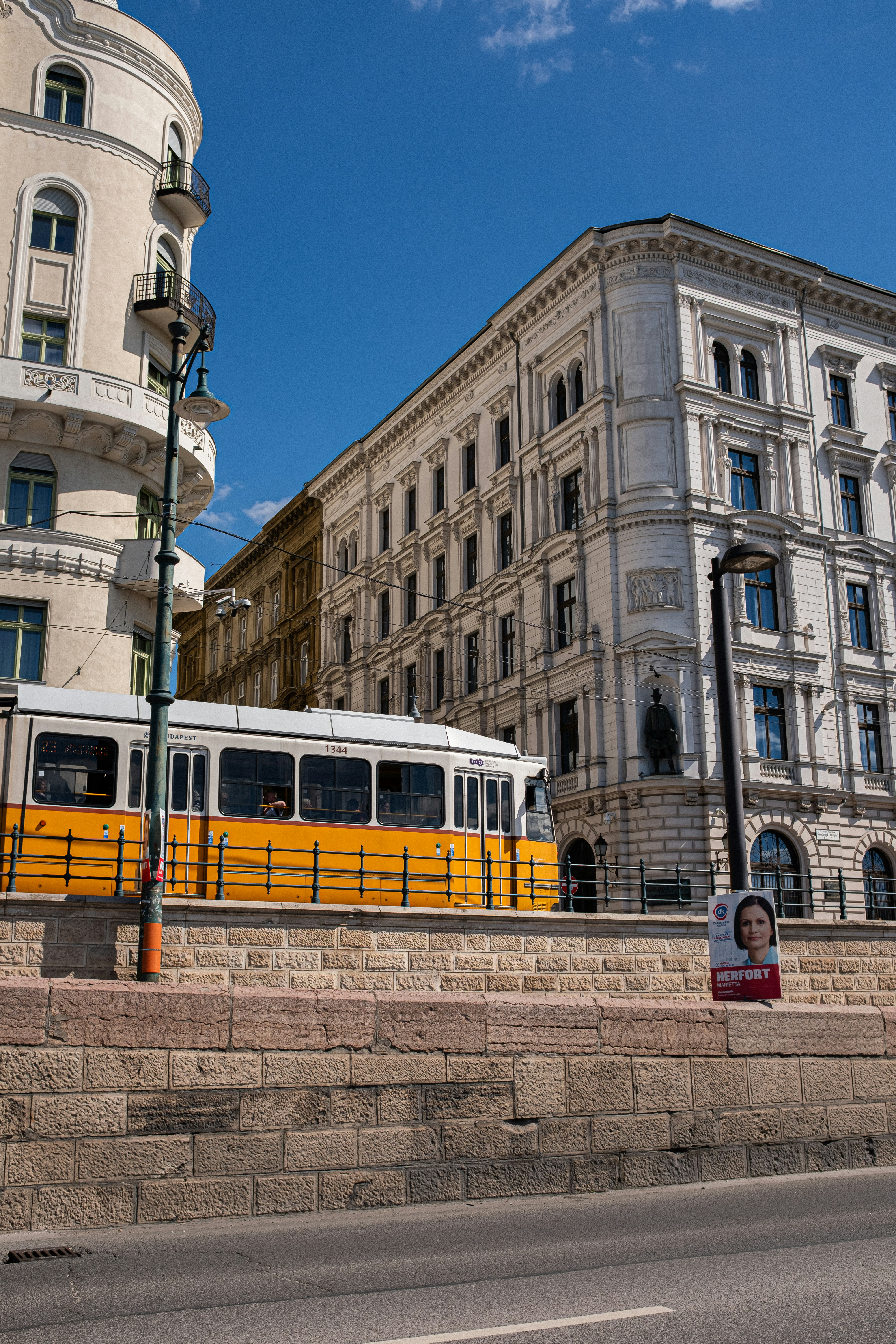 A Sunny Streetcar Between Historic Facades