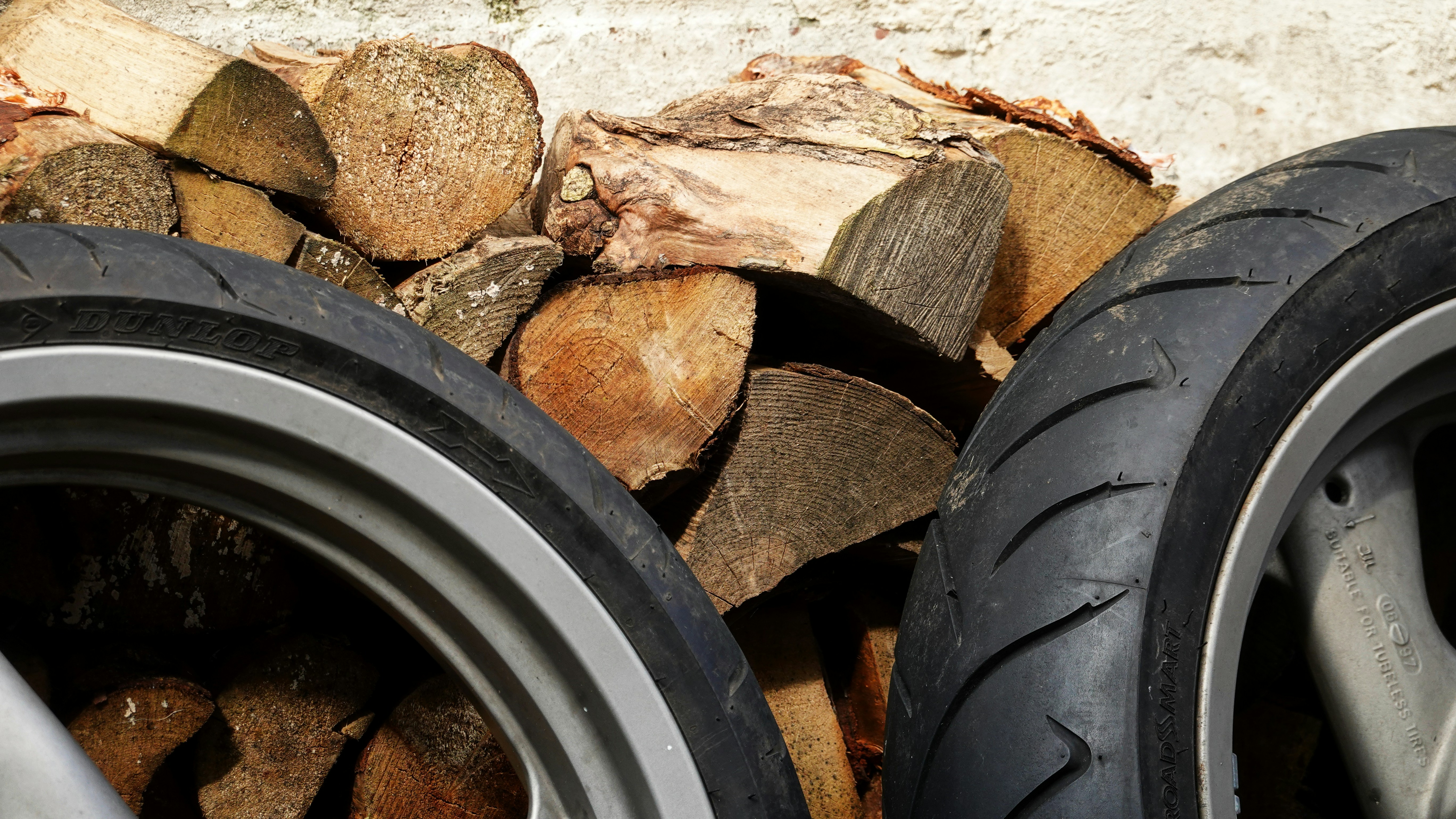 Tire Tangle: Stacked Logs Framed by Circular Rims