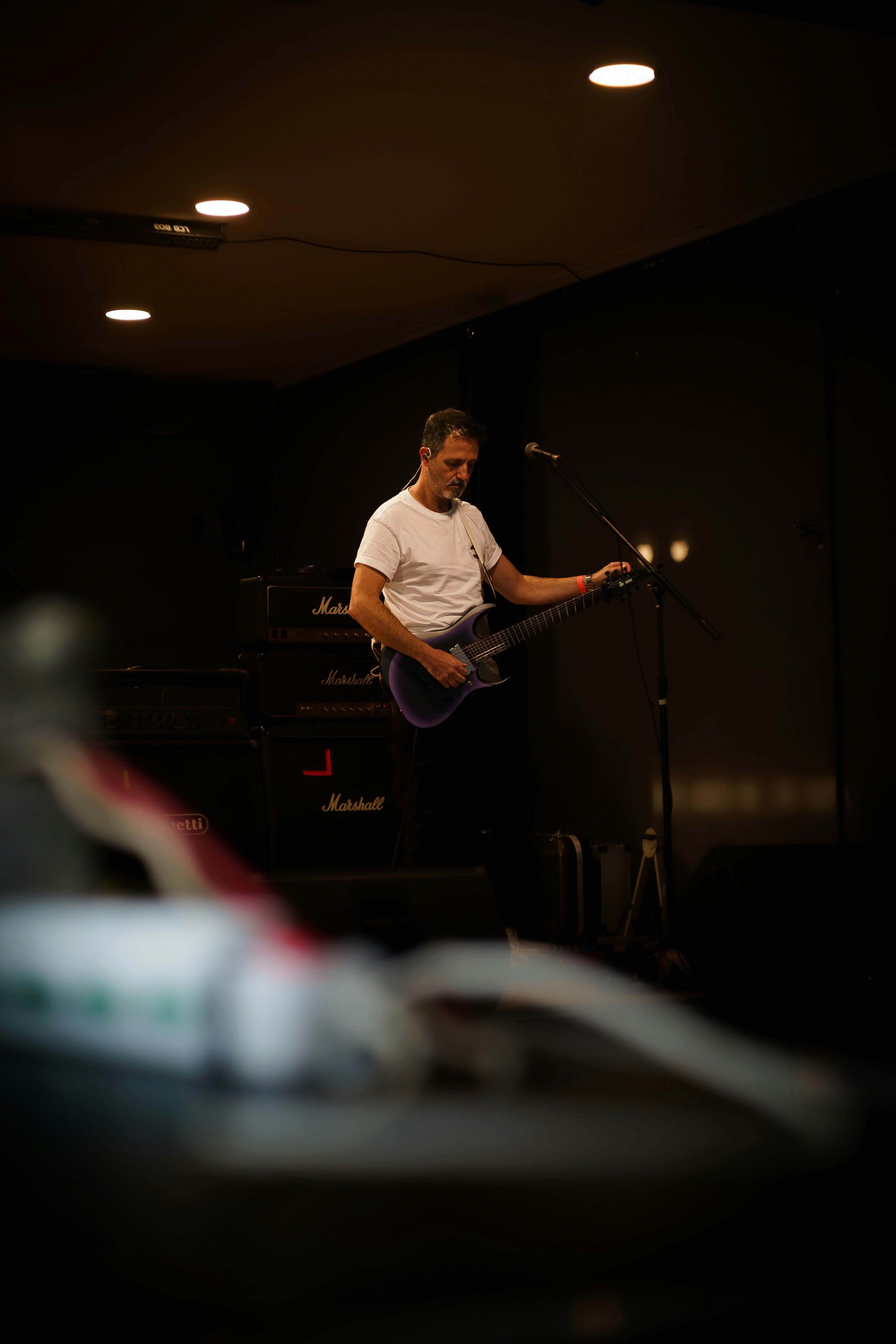 Midnight Strings: Guitarist in a Dim Stage