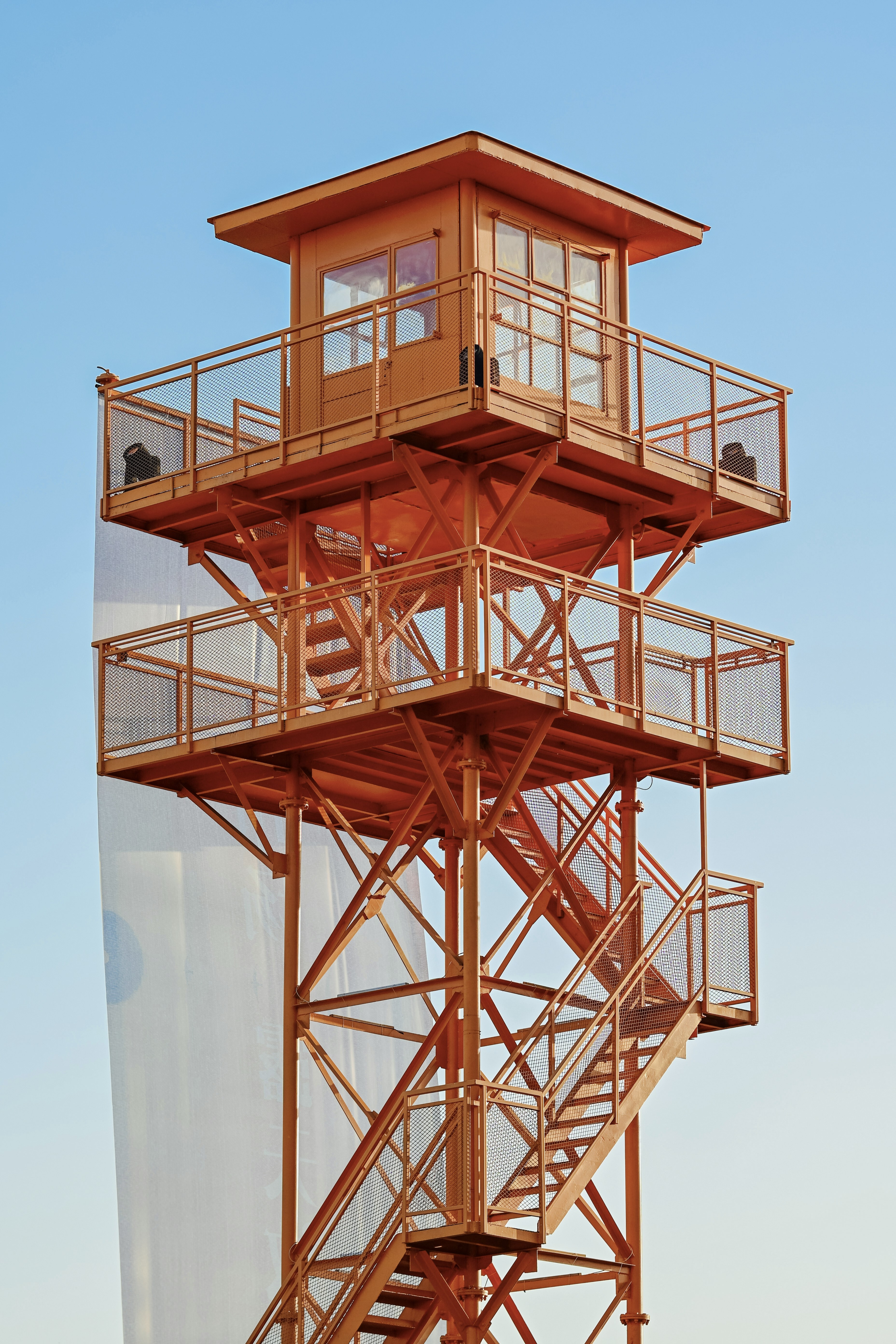 Red Watchtower Ascending: A Steel Skyline in Clear Sky