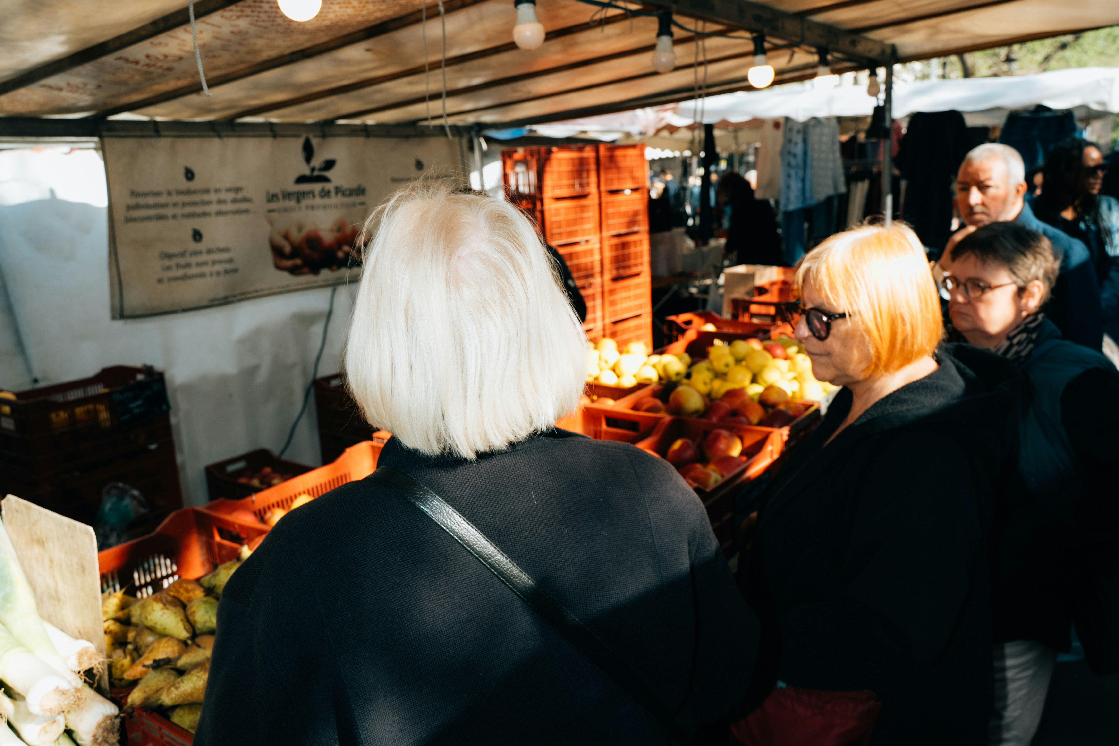 Market Portrait: Faces and Fruit under Dappled Light