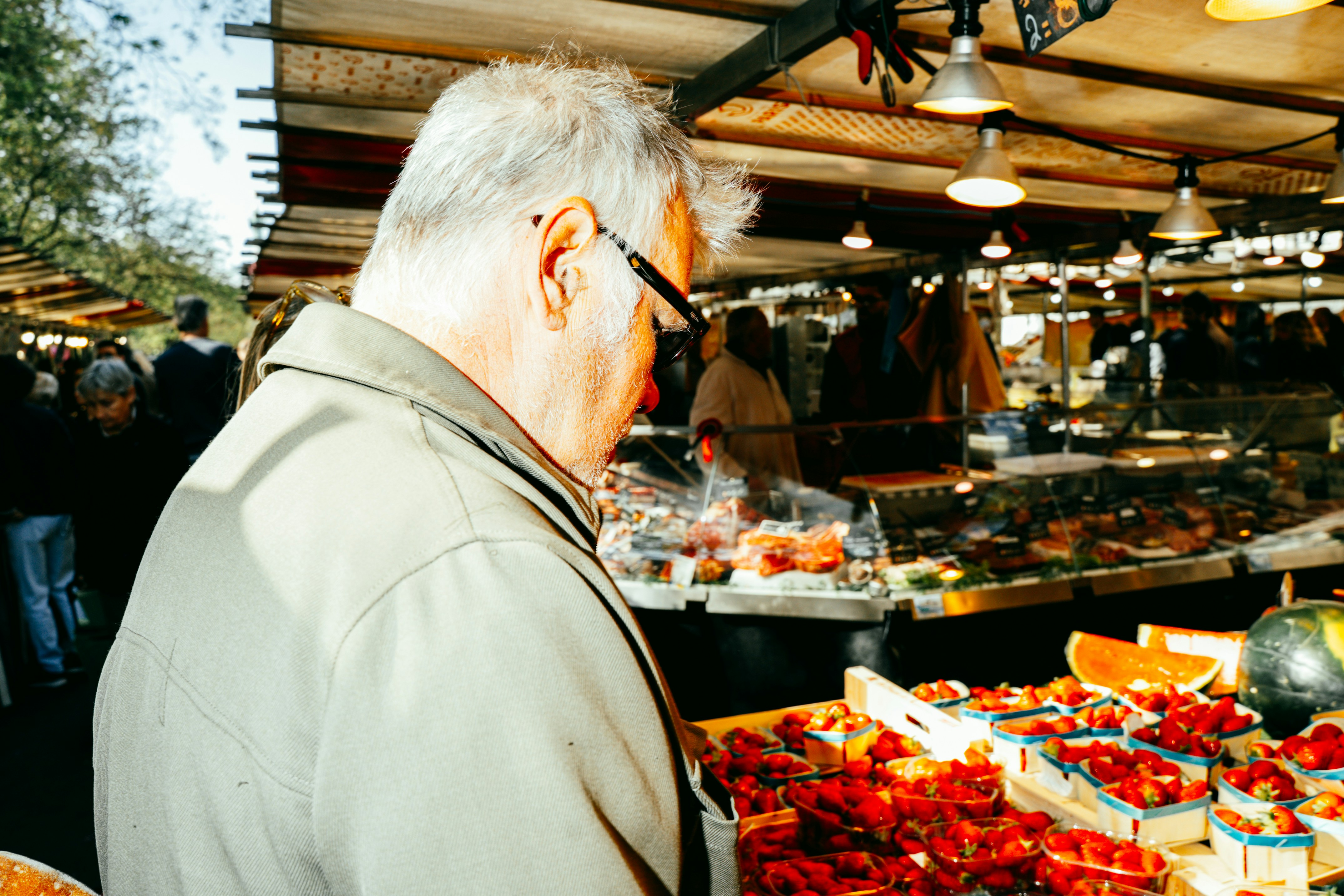 Market Portrait: The Quiet Buyer in a Colorful Stall