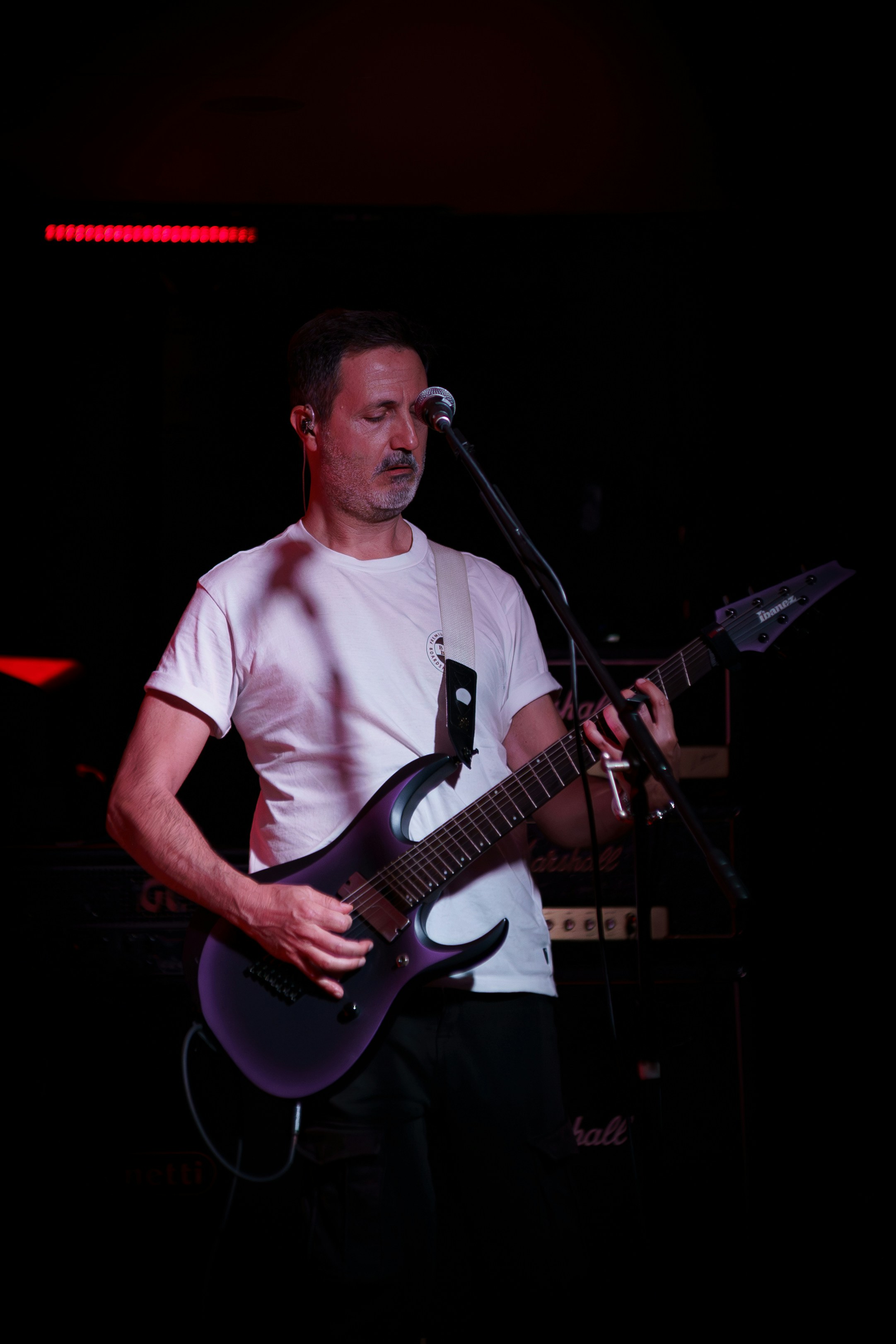 Midnight Guitarist Under Stage Glow