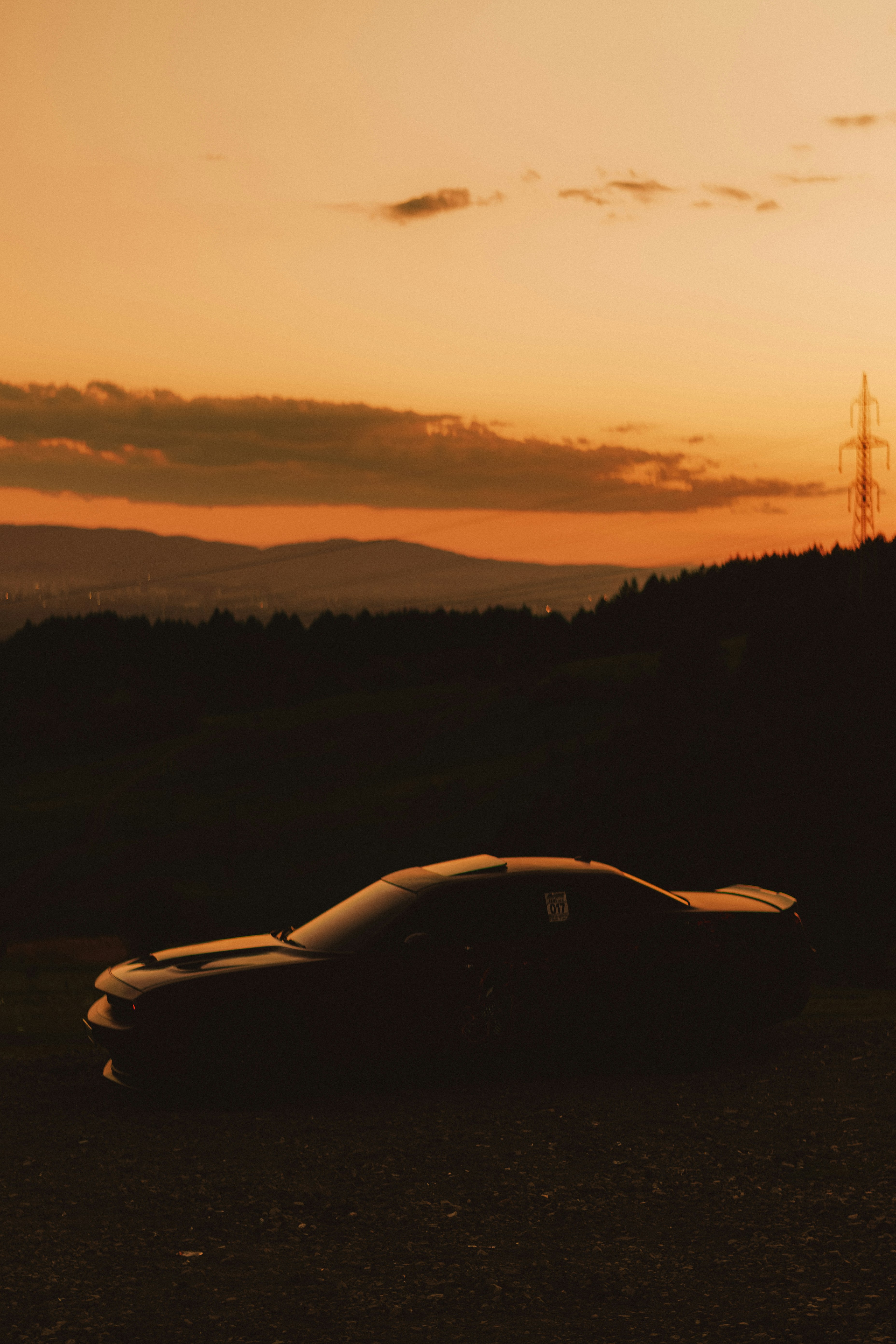 Sunset Silhouette: A Sleek Car at Dusk