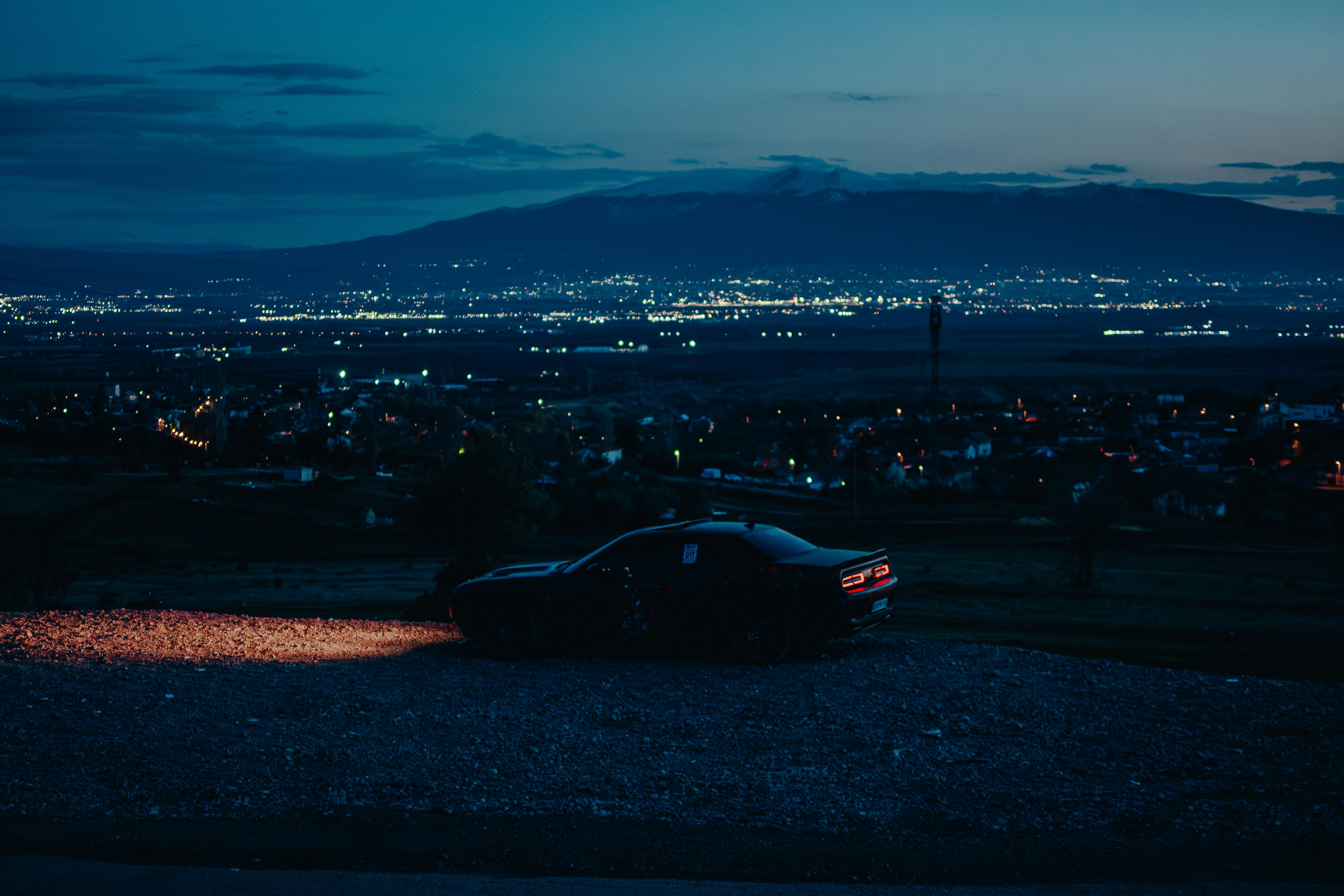 Midnight Noir: A Car of Ember in the City’s Shadow
