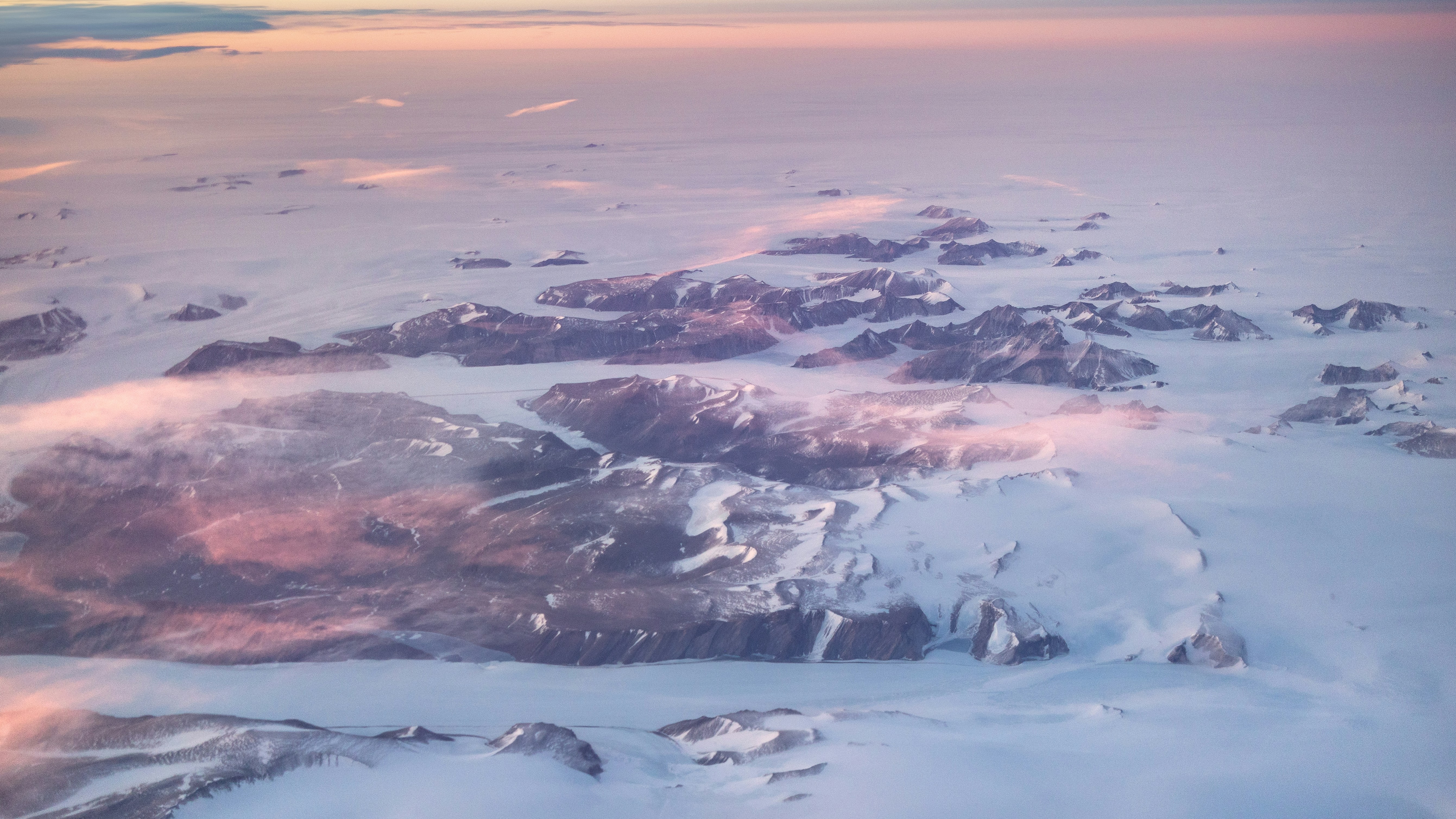 Aurora of Snow: A Polar Dawn Over Quiet Ridges