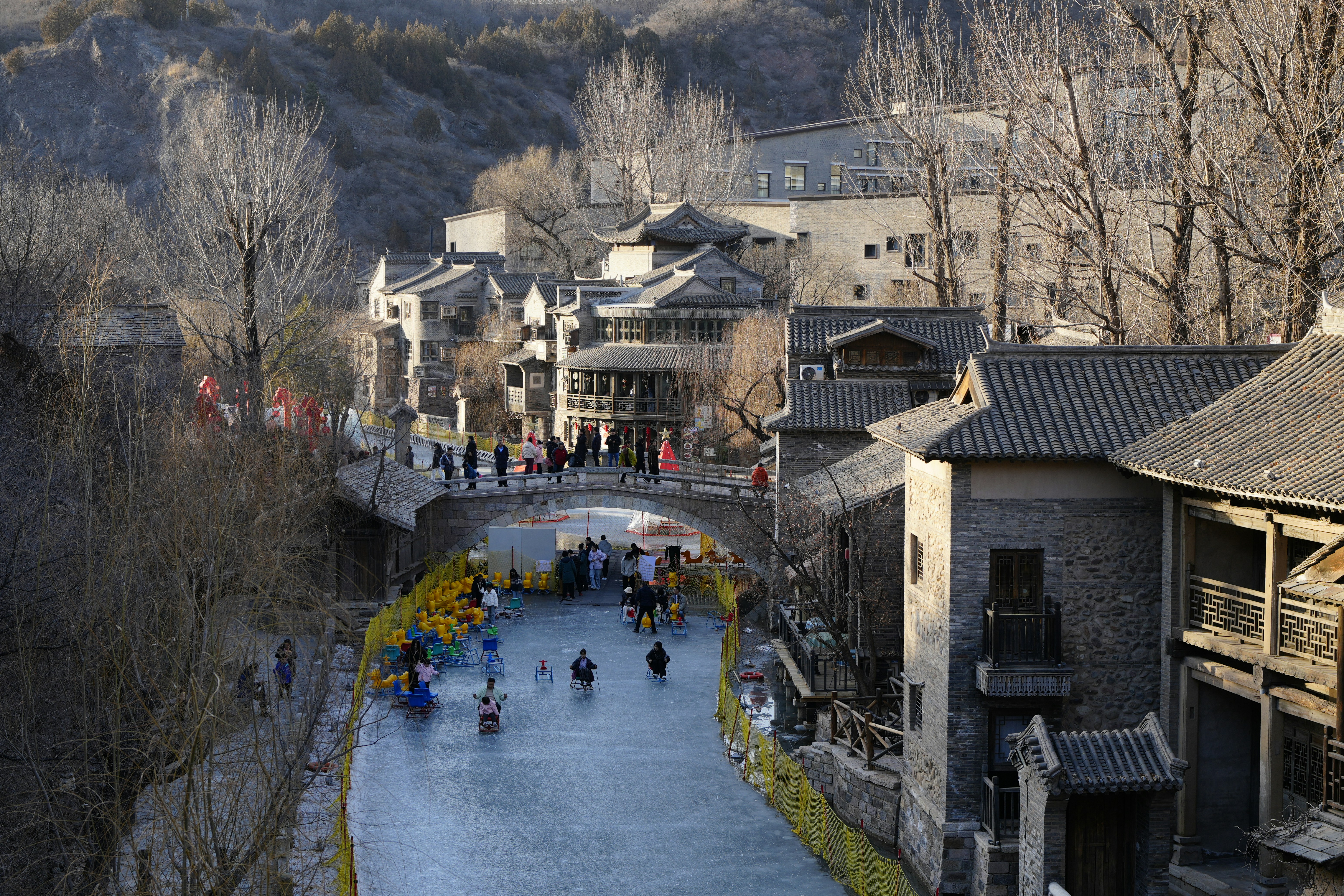 Wharfside Village Carnival: People and Canal Under Stone Bridge