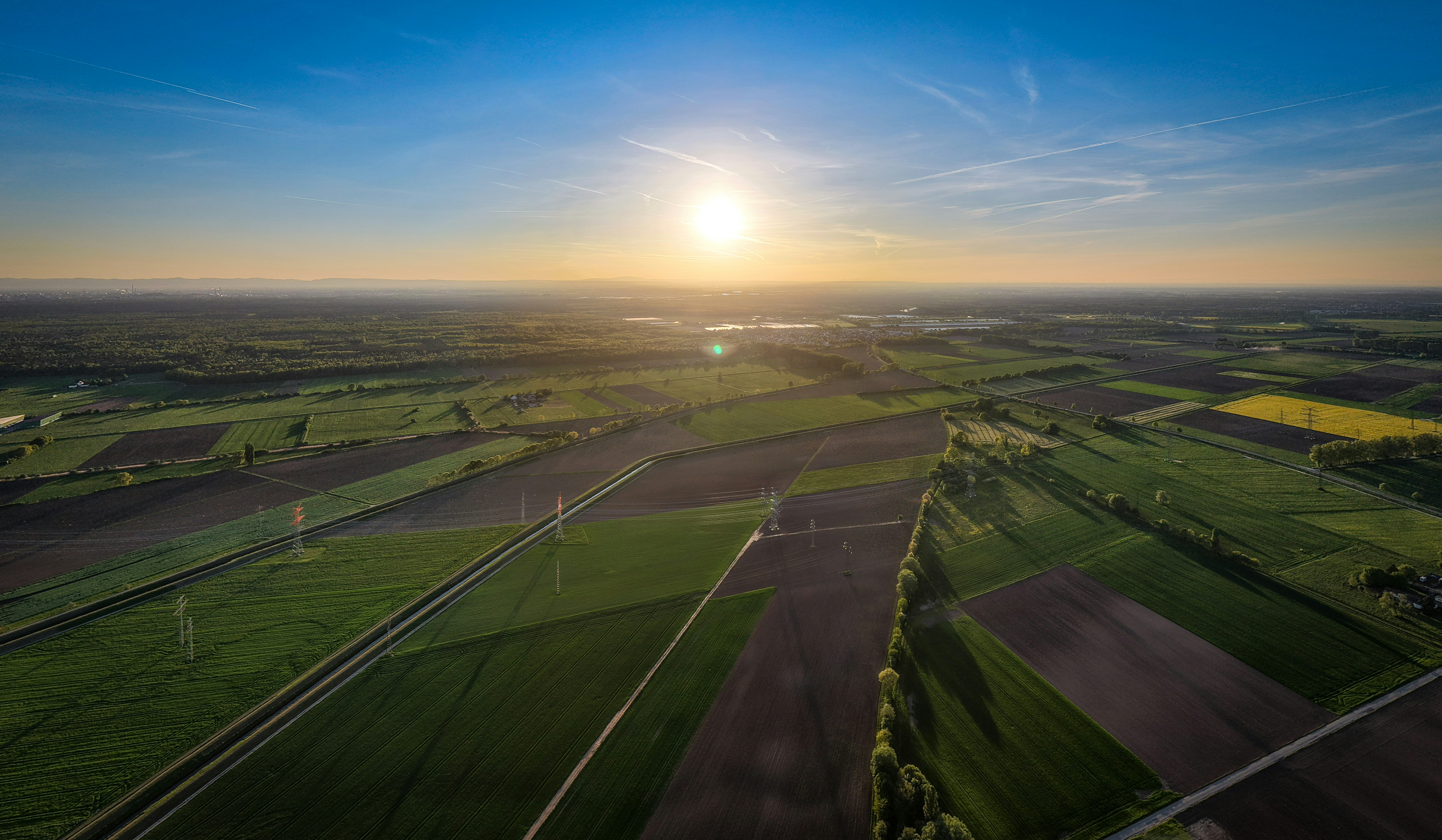 Sunlit Farmland Horizon: Aerial Quiet at Dusk
