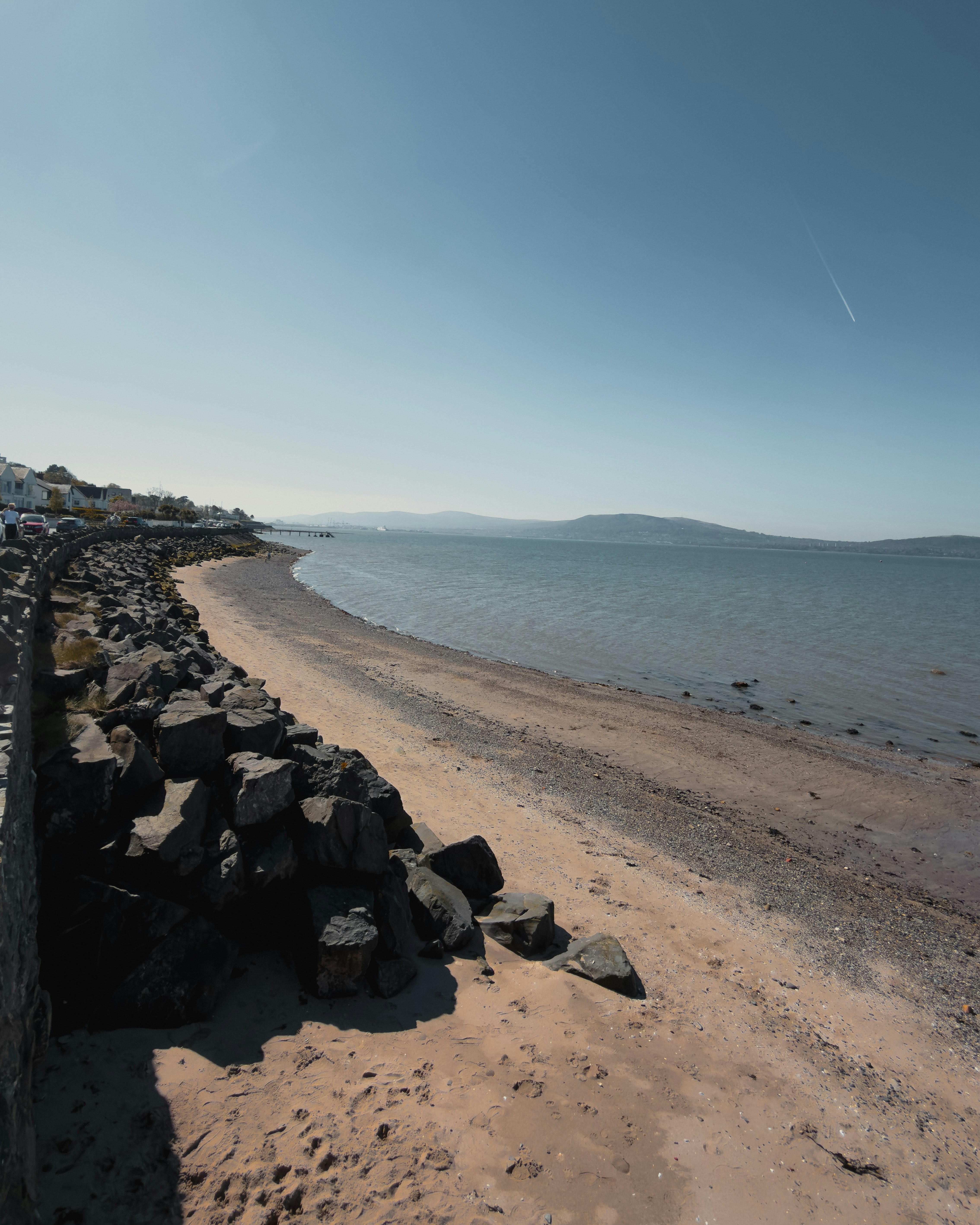 Coastal Borderline: Rocks, Sand, and a Distant Calm