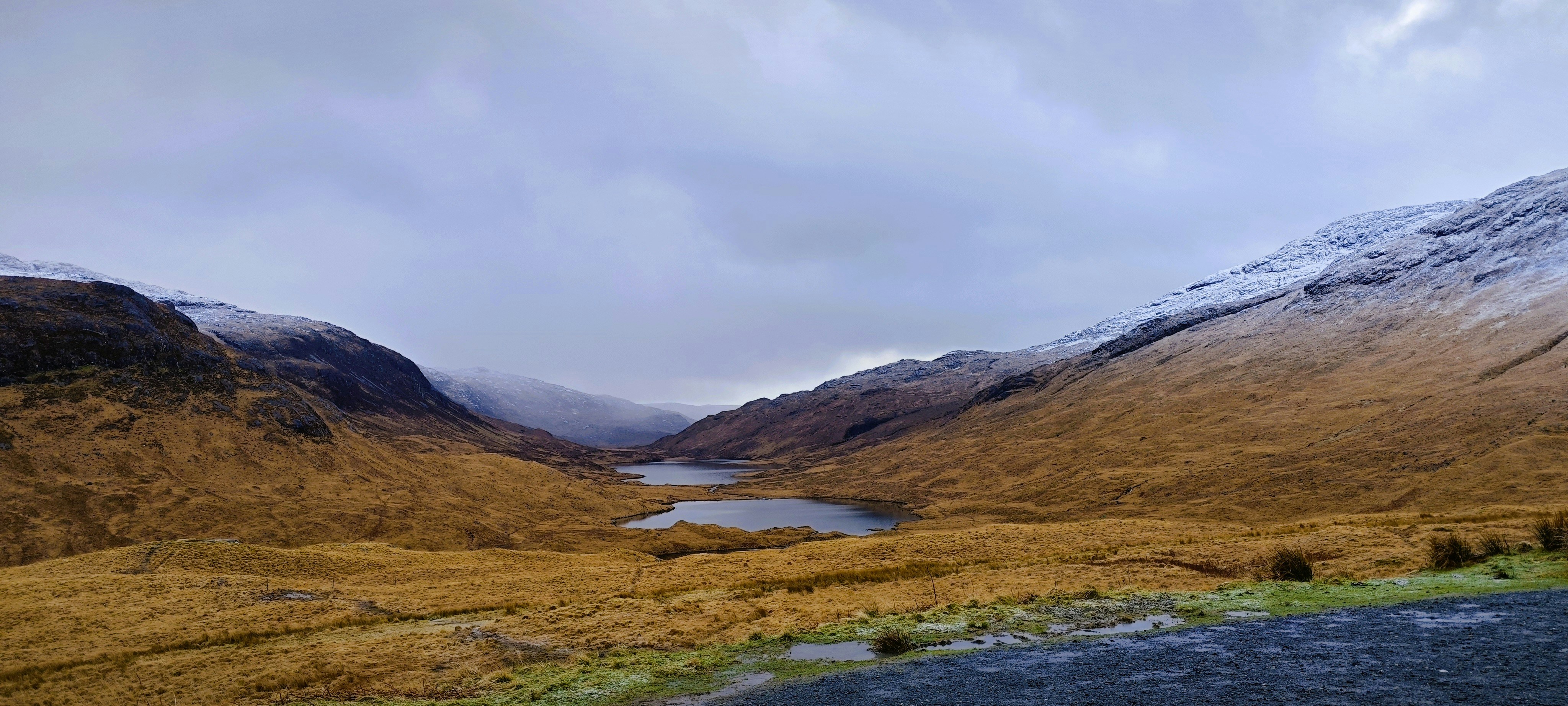 Valley Mirror: Snow-kissed Peaks Over a Quiet Moor