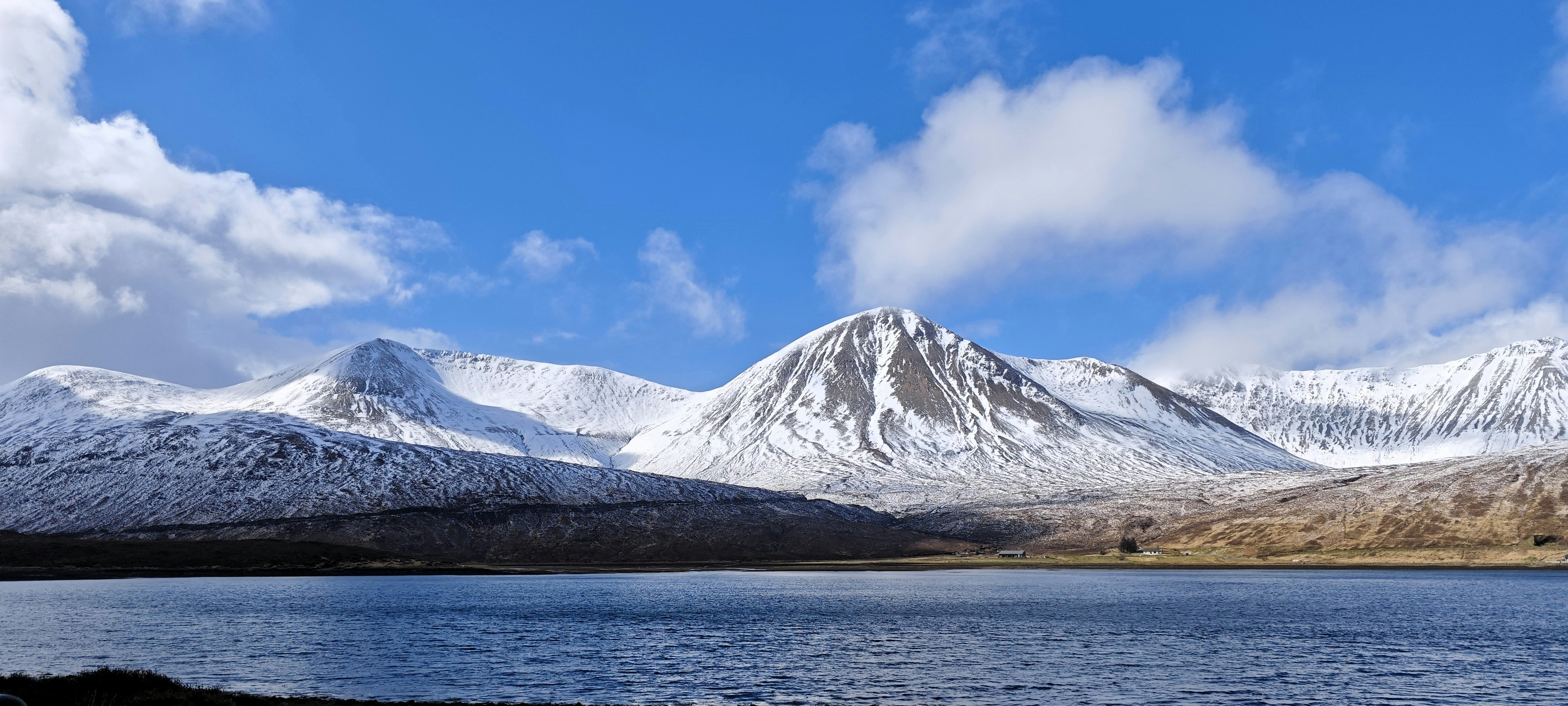 Snow-kissed Peaks Across a Quiet Fjord
