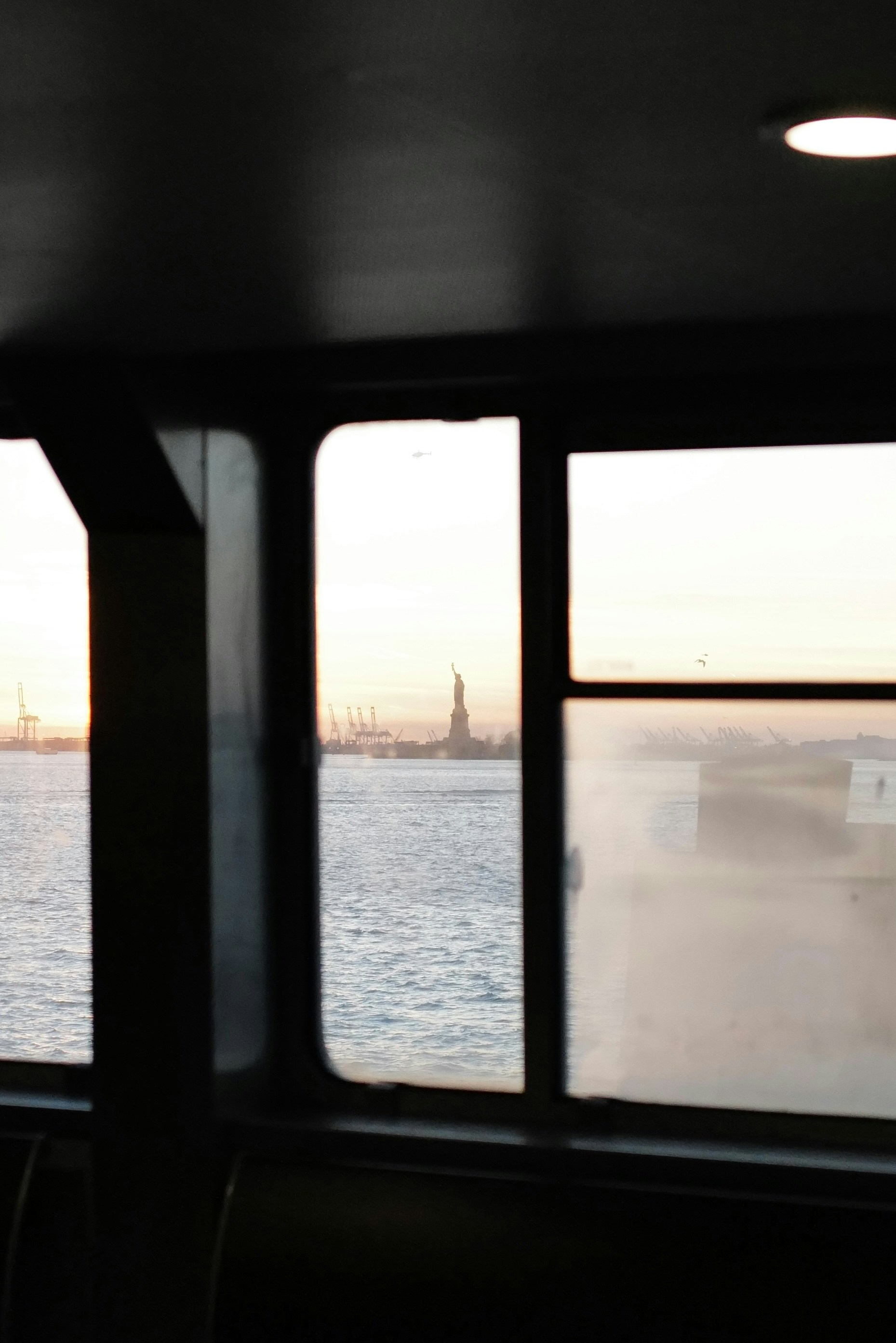 Harbor Window: Statue of Liberty Framed by a Ferry Interior