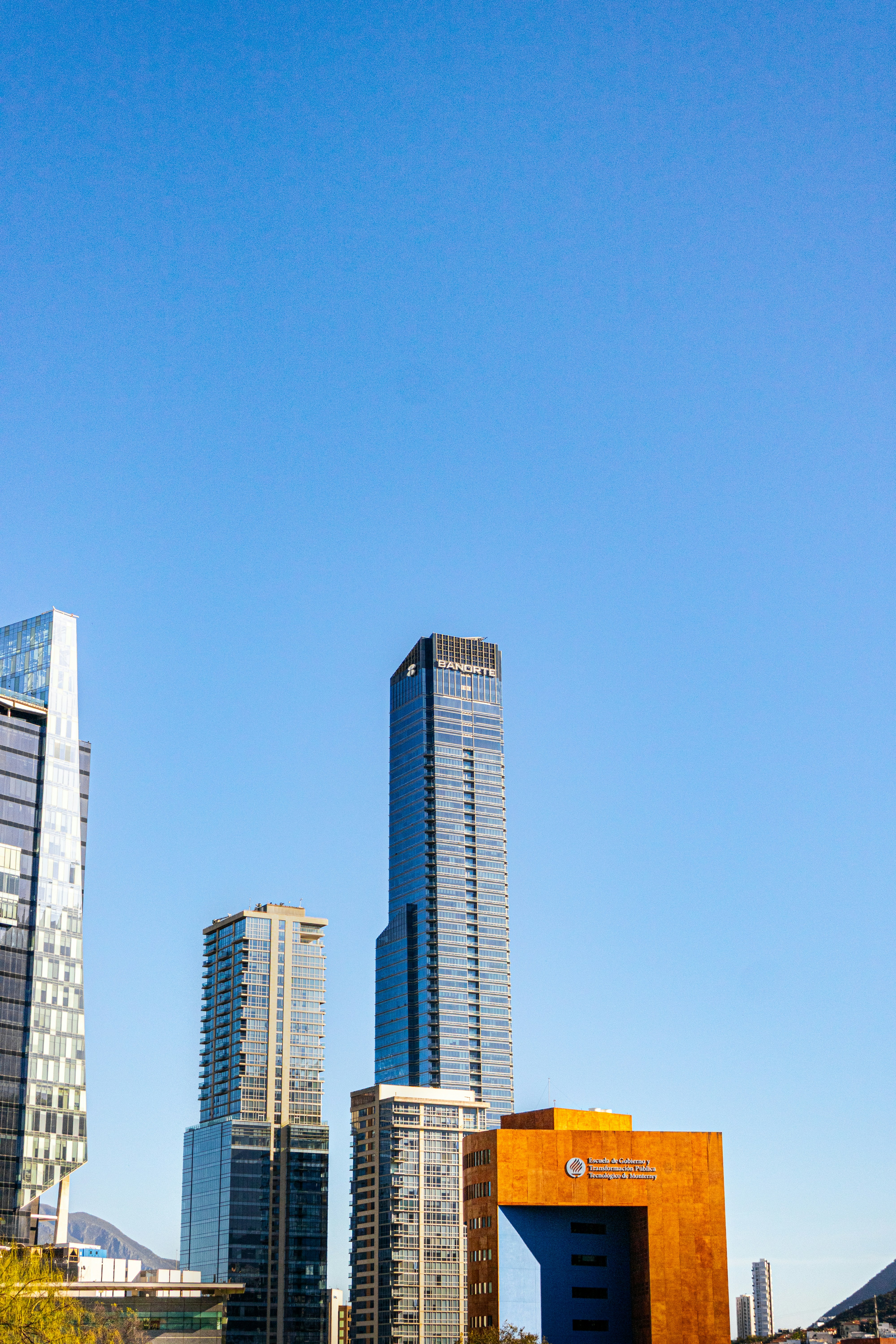 Vertical Ascension: A City Tower Rises Against Azure Sky