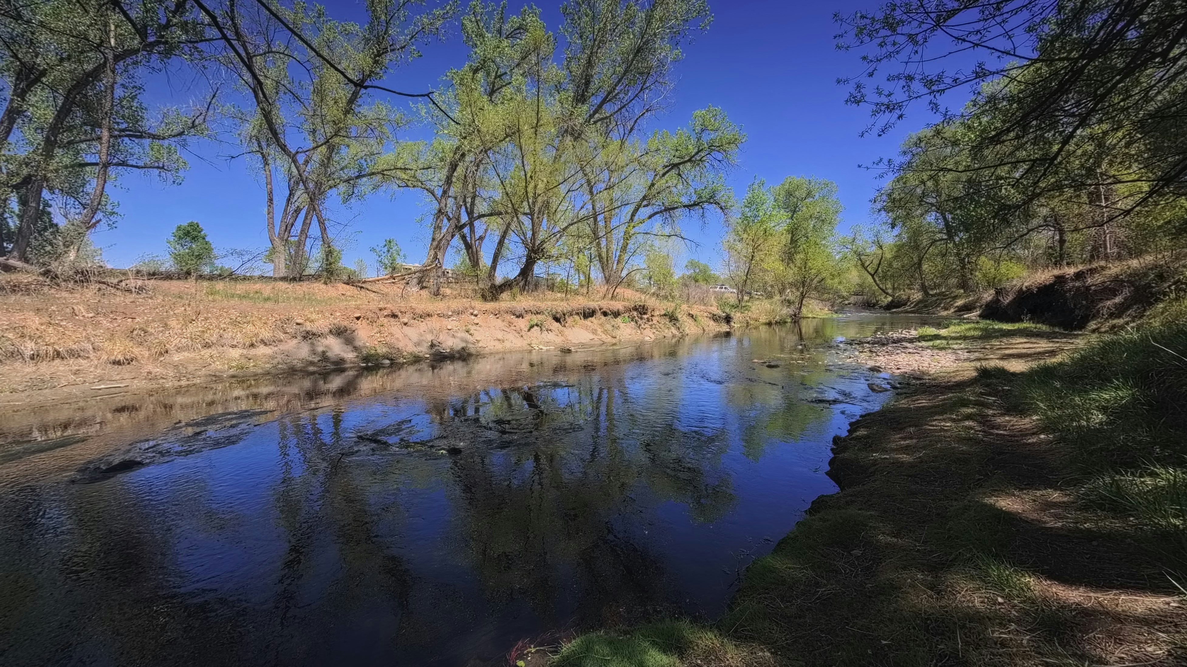 River Reflections Under a Clear Sky