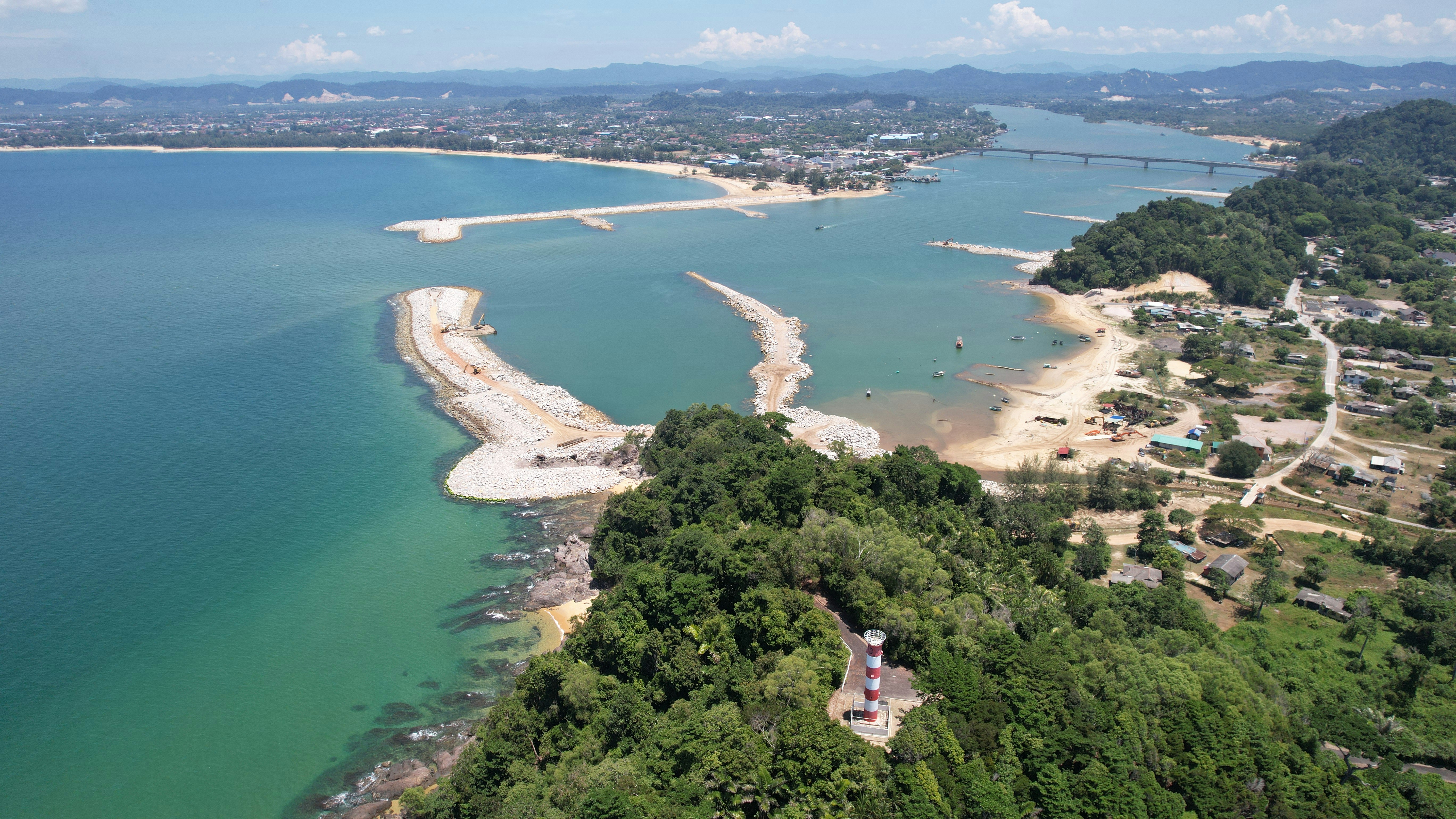 Overlook of a Curved Beach Crescent with Pine-Clad Promenade and Lighthouse
