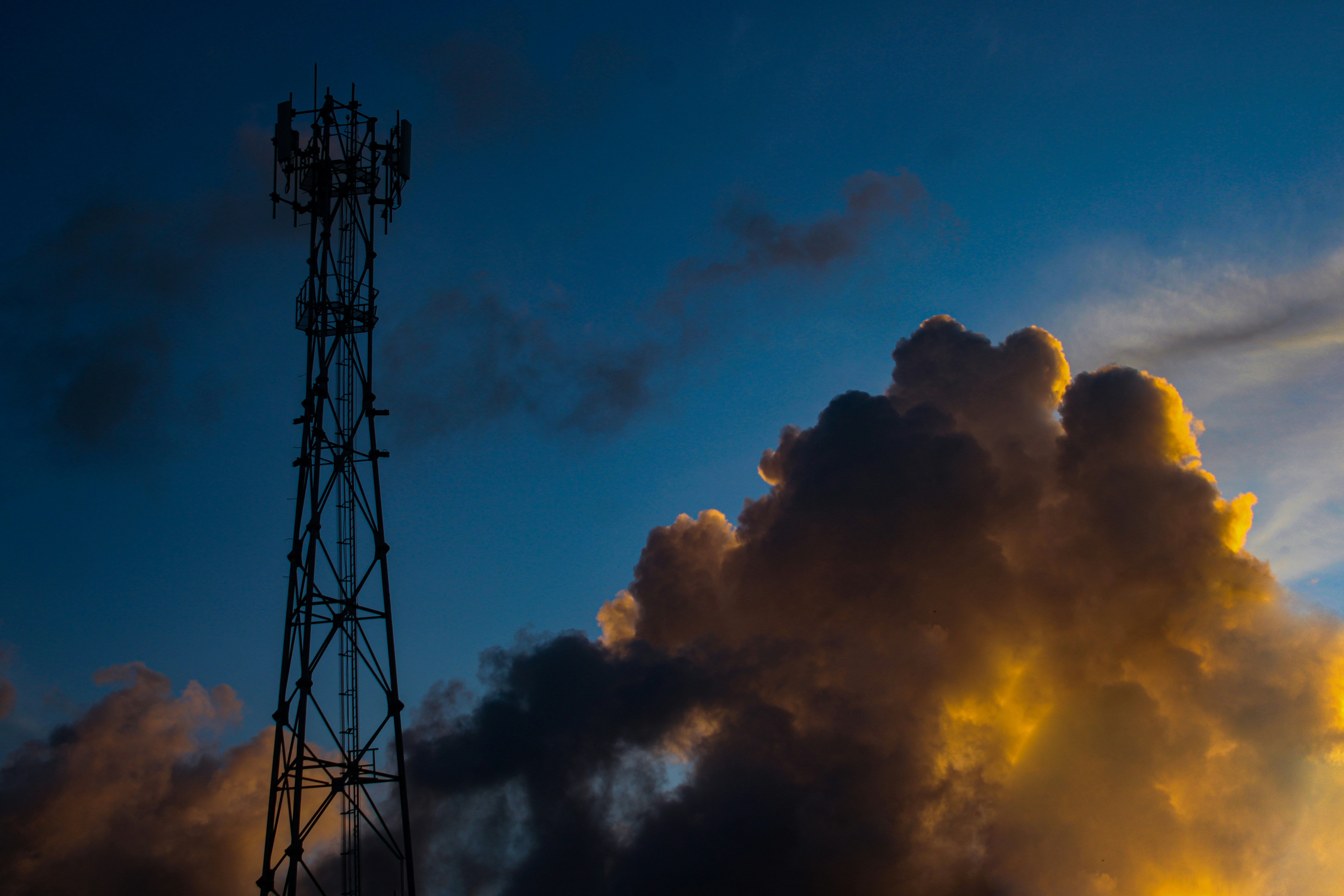 Signal Tower at Dusk: Skyward Lattice Amidst Billowing Clouds