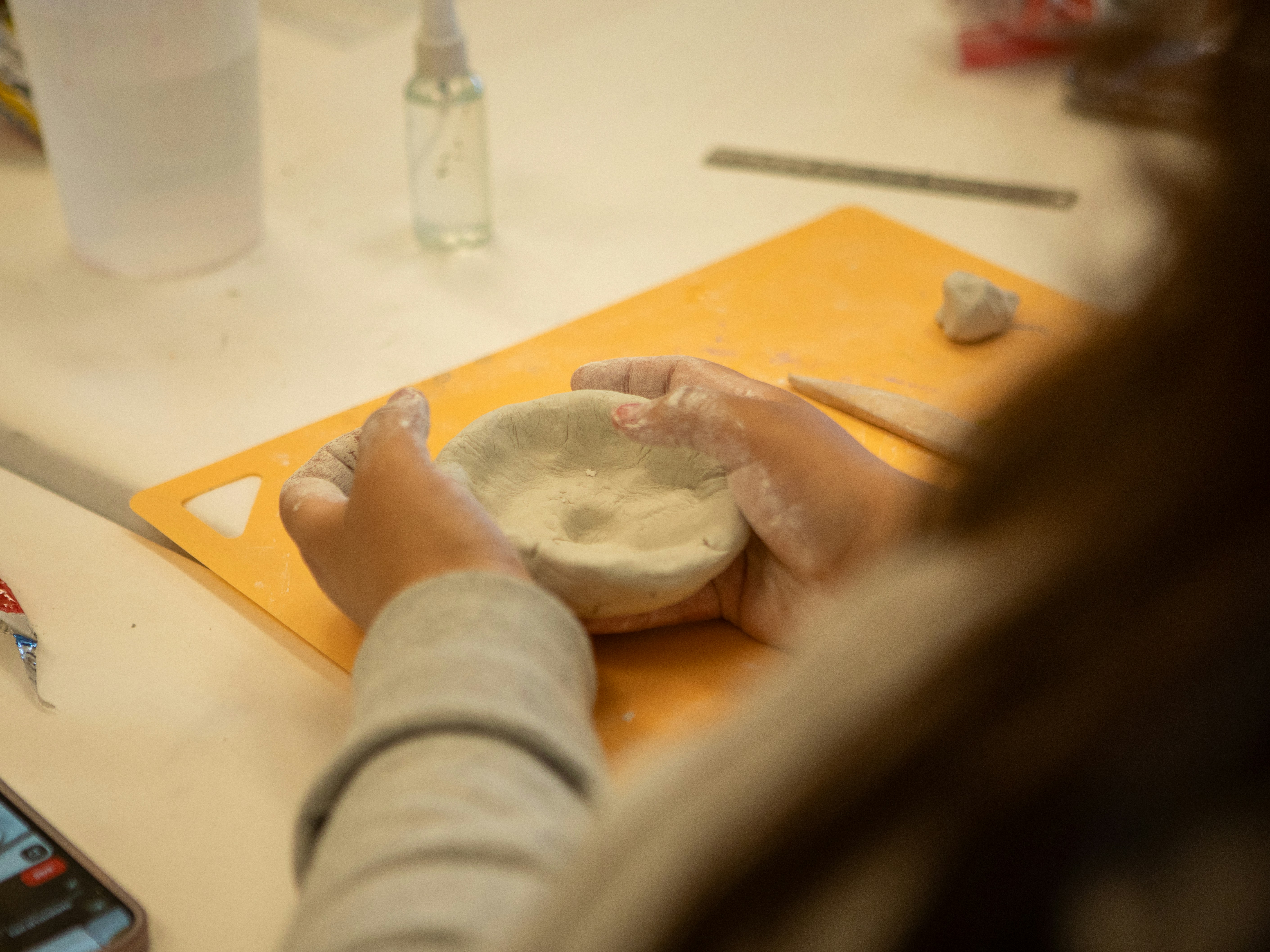 Hands at the Wheel of Clay: Crafting a Small Ceramic Dish