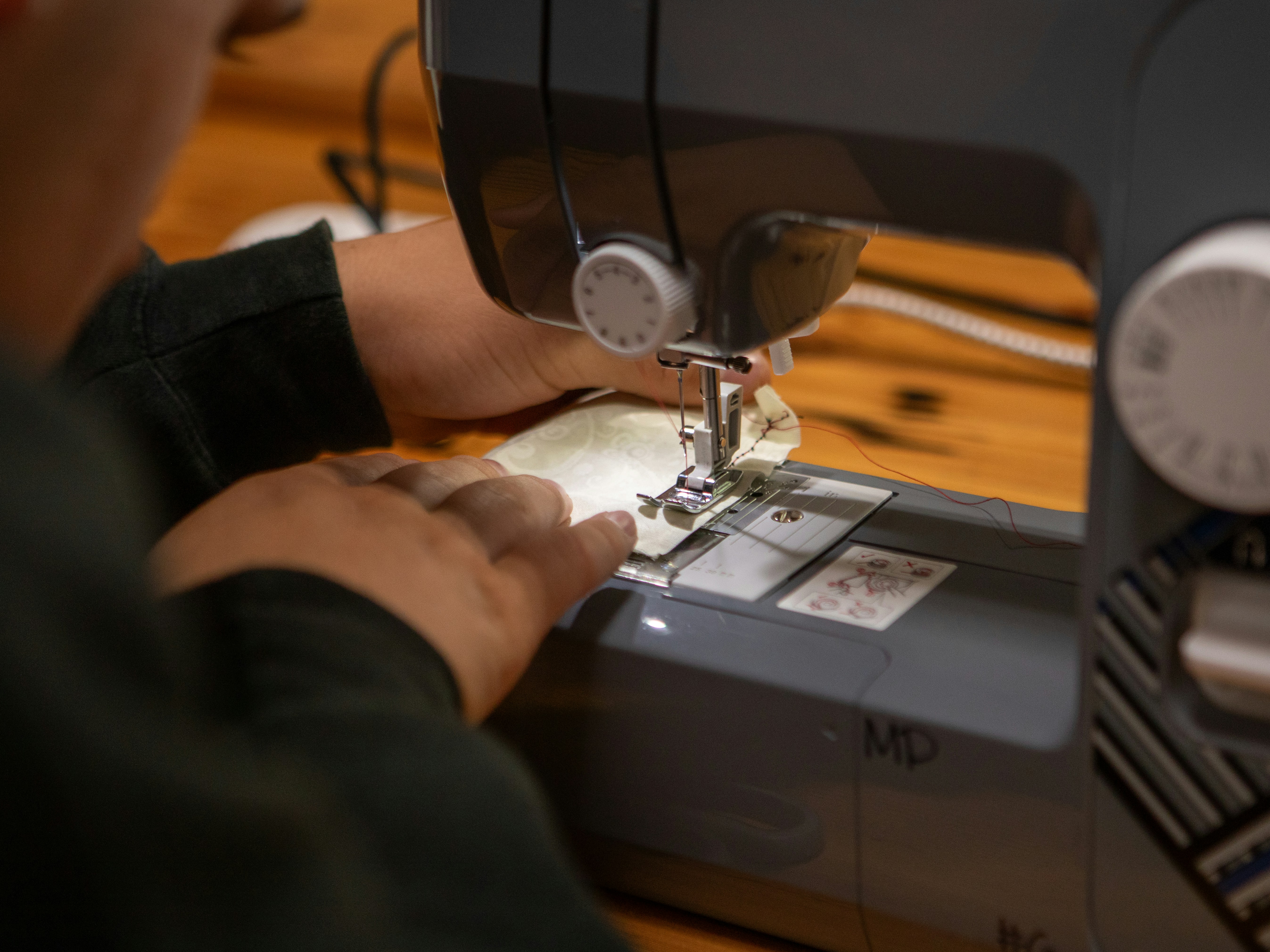 Quiet Precision: A Hands-On Moment at the Sewing Machine