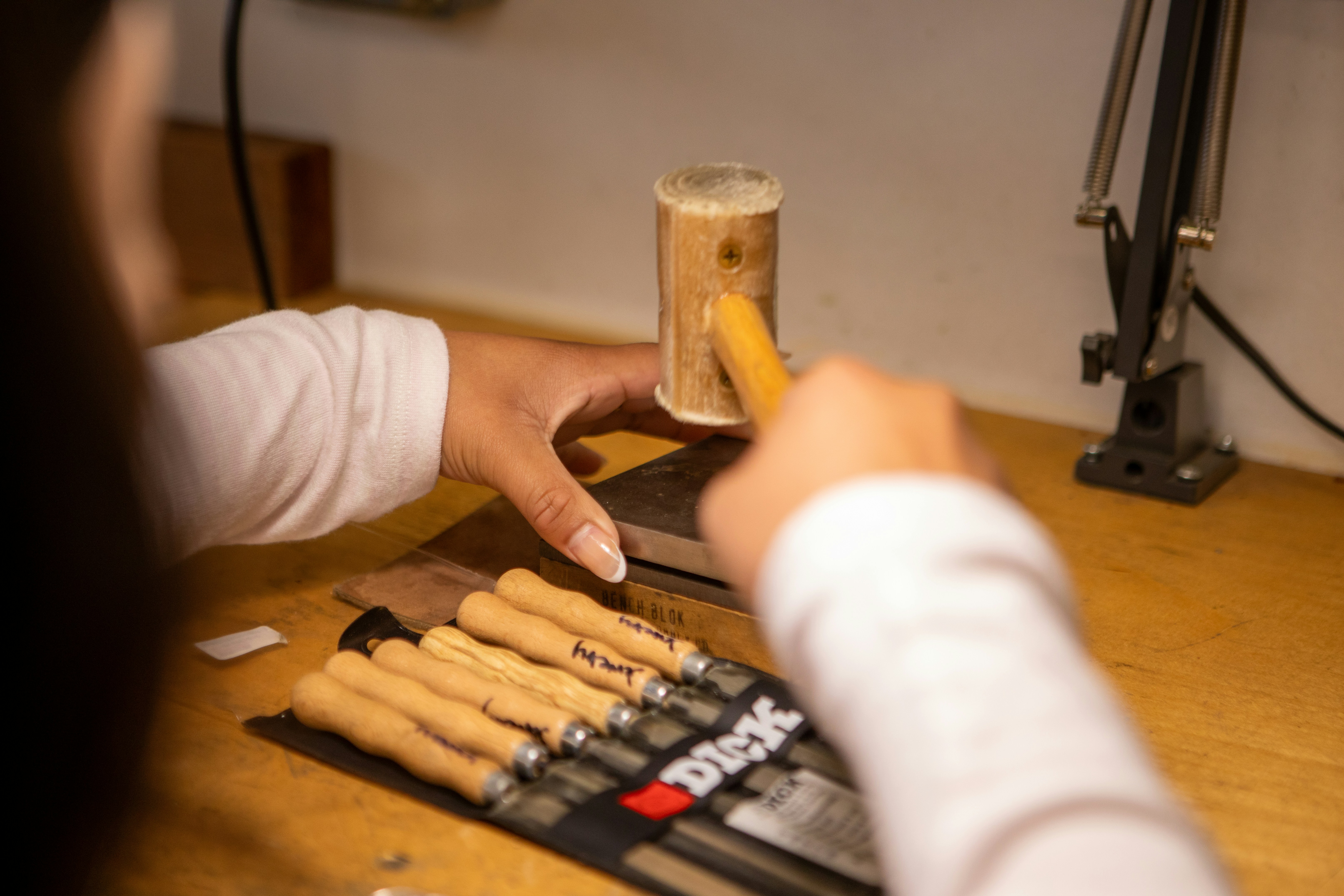 Flick of the Gouge: Craftsman’s Hands at Work on a Wooden Mallet