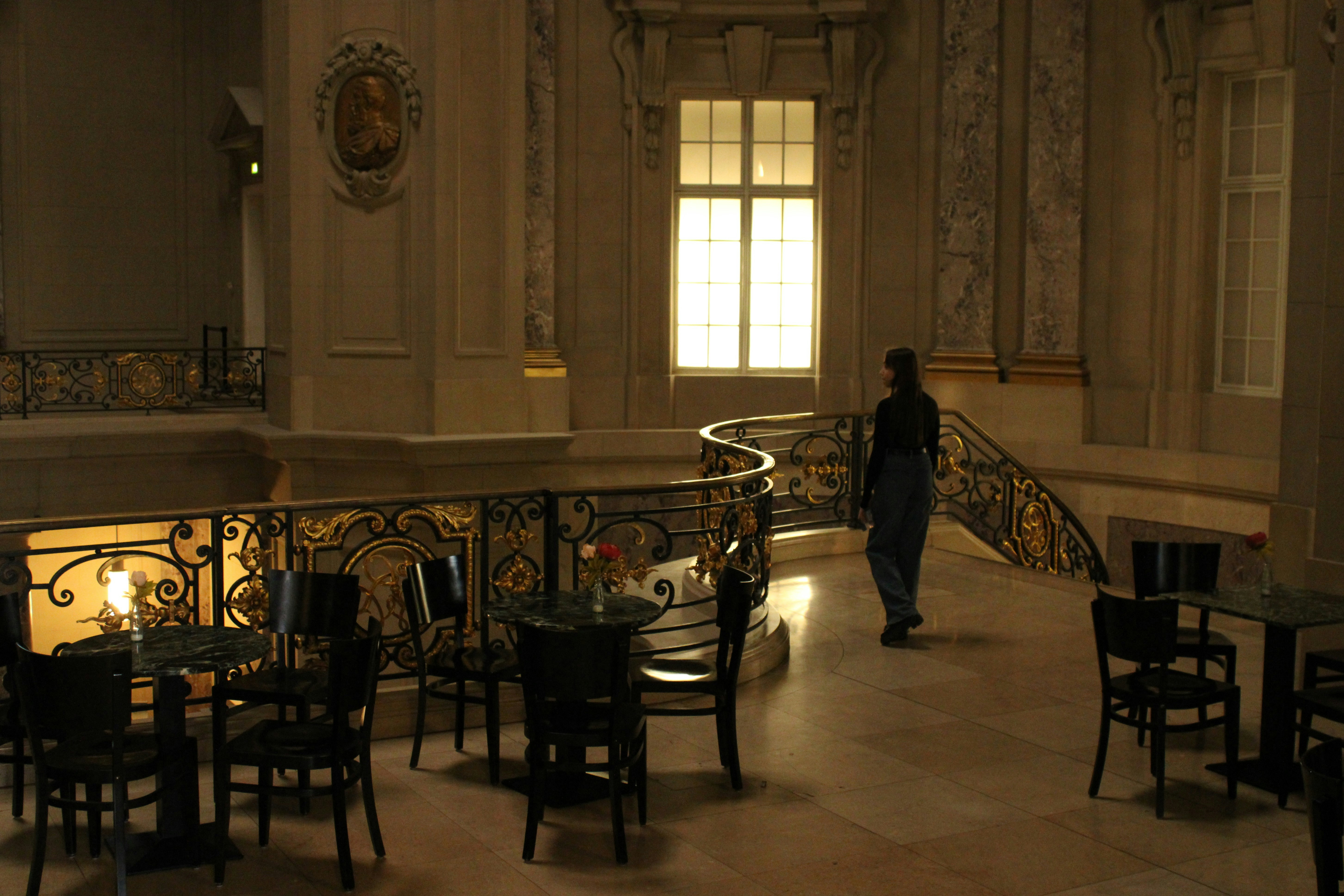 Dim Ballroom, Silhouetted Visitor Crossing the Golden Balcony