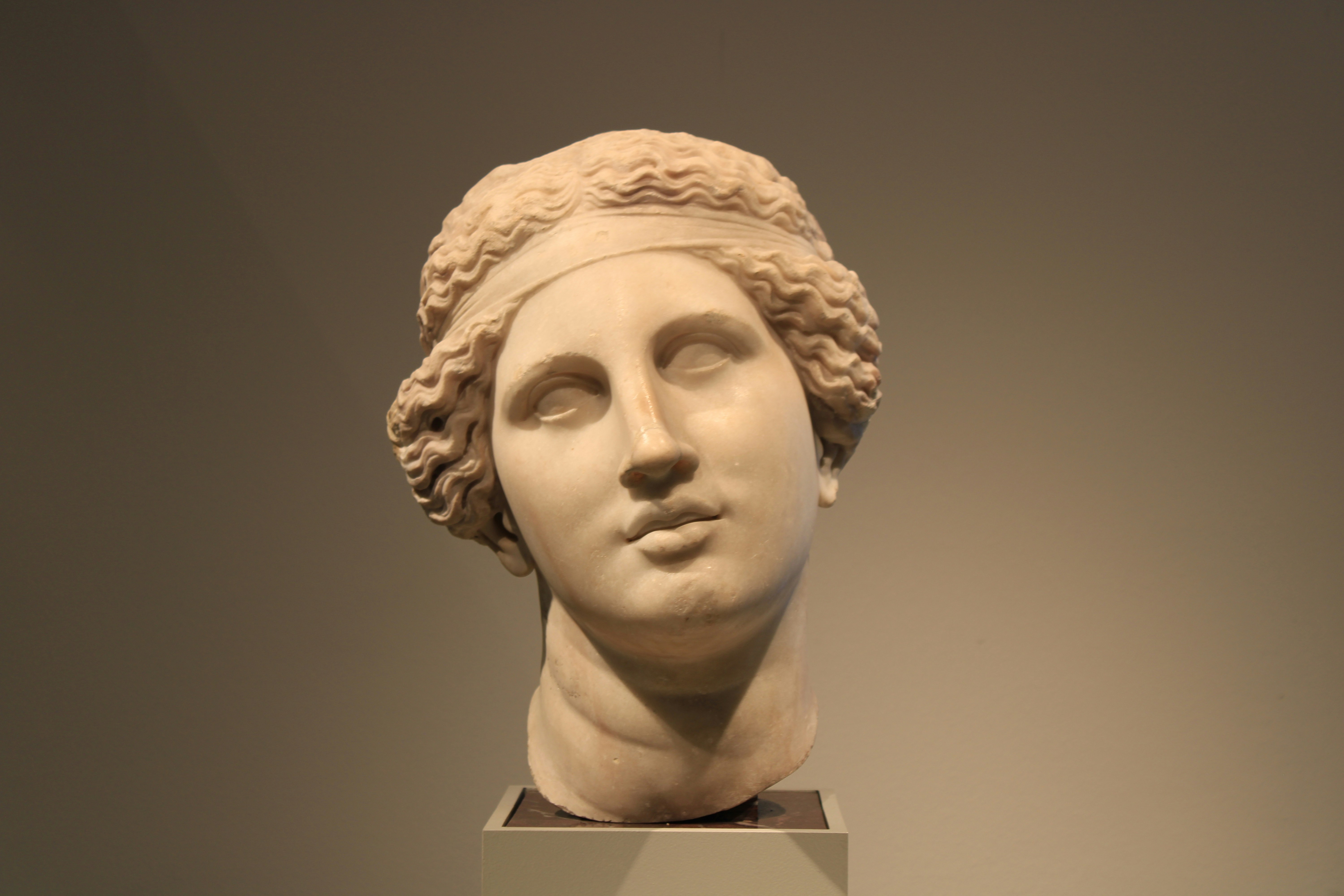 Serene Classical Bust: Marble Portrait Under Soft Gallery Light