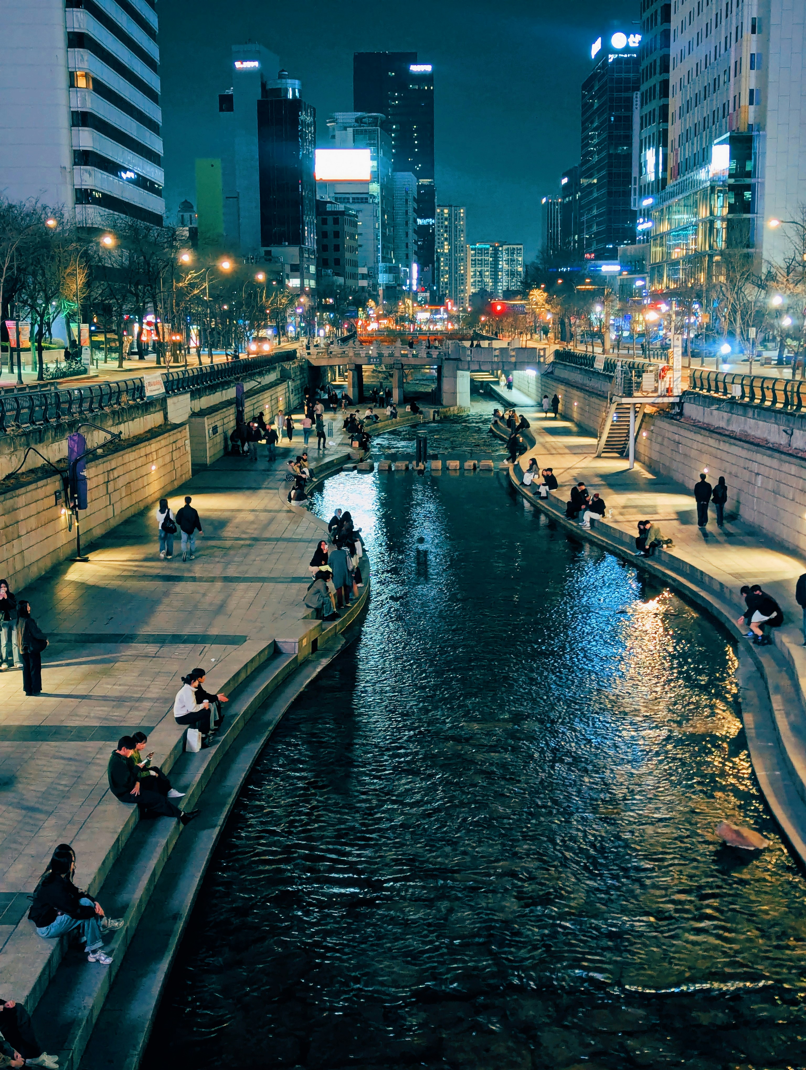 City Canal at Dusk: People, Steps, and Reflections