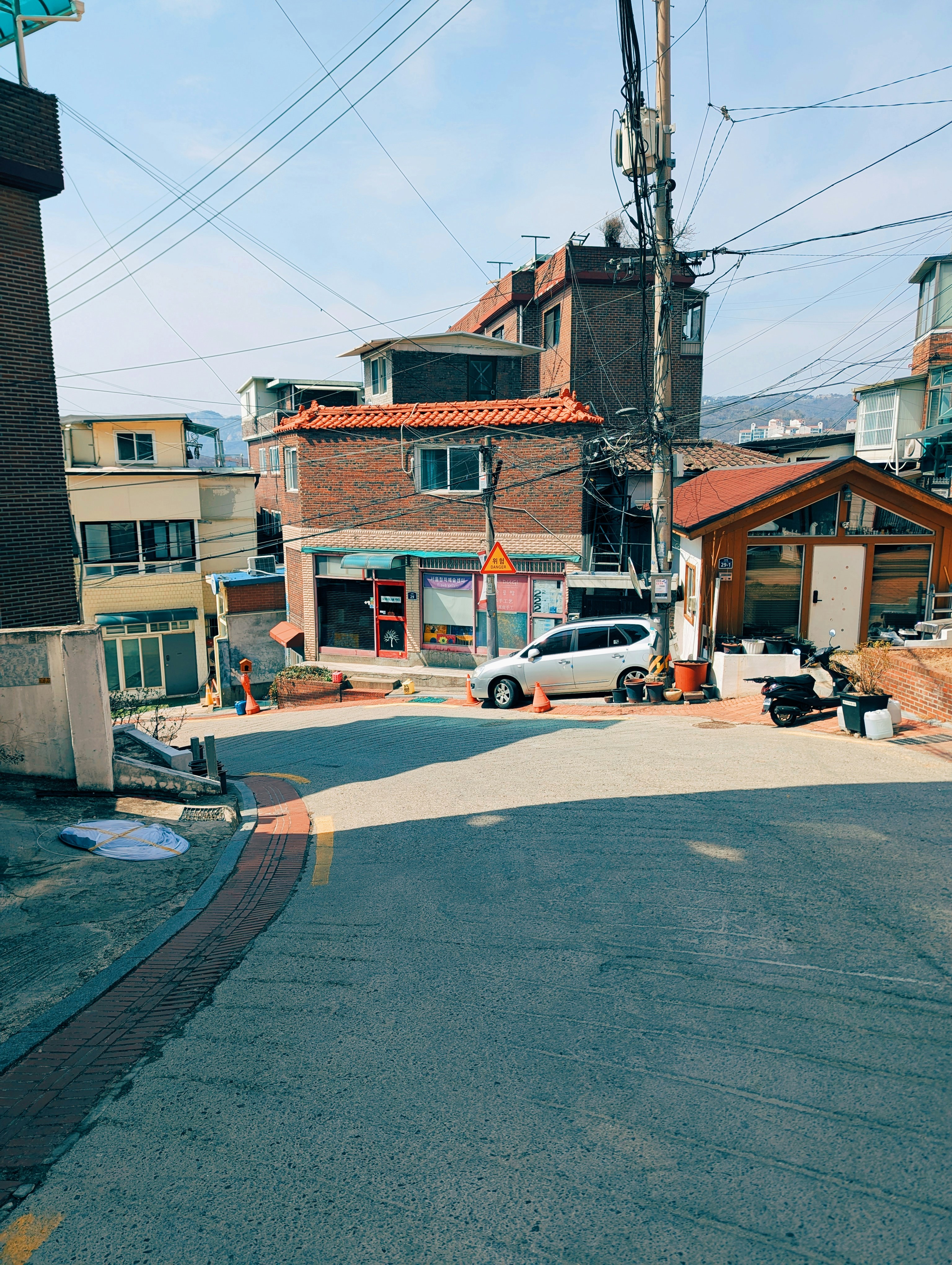 Sunlit Street Scene with Brick Buildings and Narrow Lane