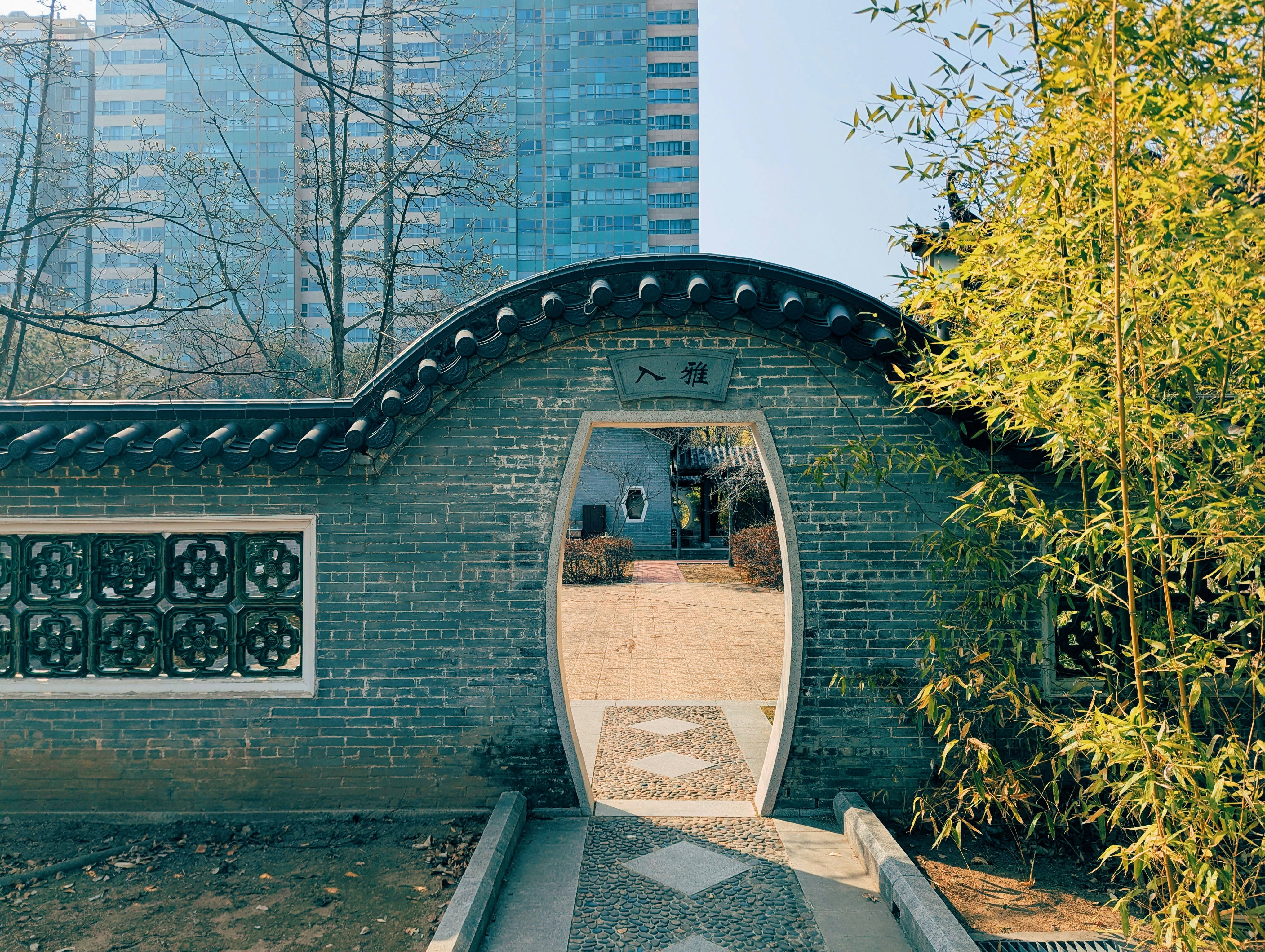 Traditional chinese garden gate with bamboo and modern building. photo ...