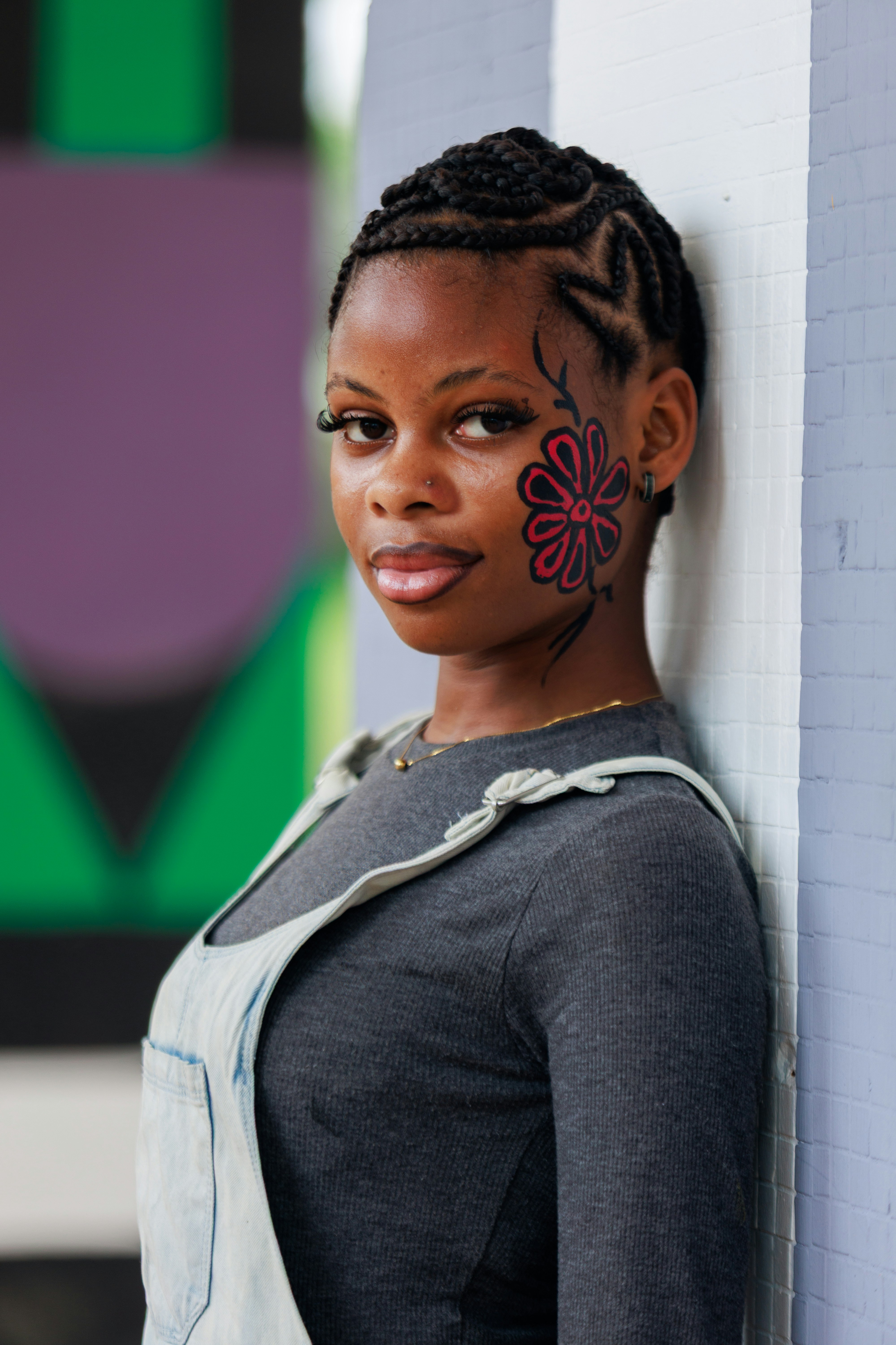 Face in Focus: A Portrait of Confidence Against Street Art Backdrop