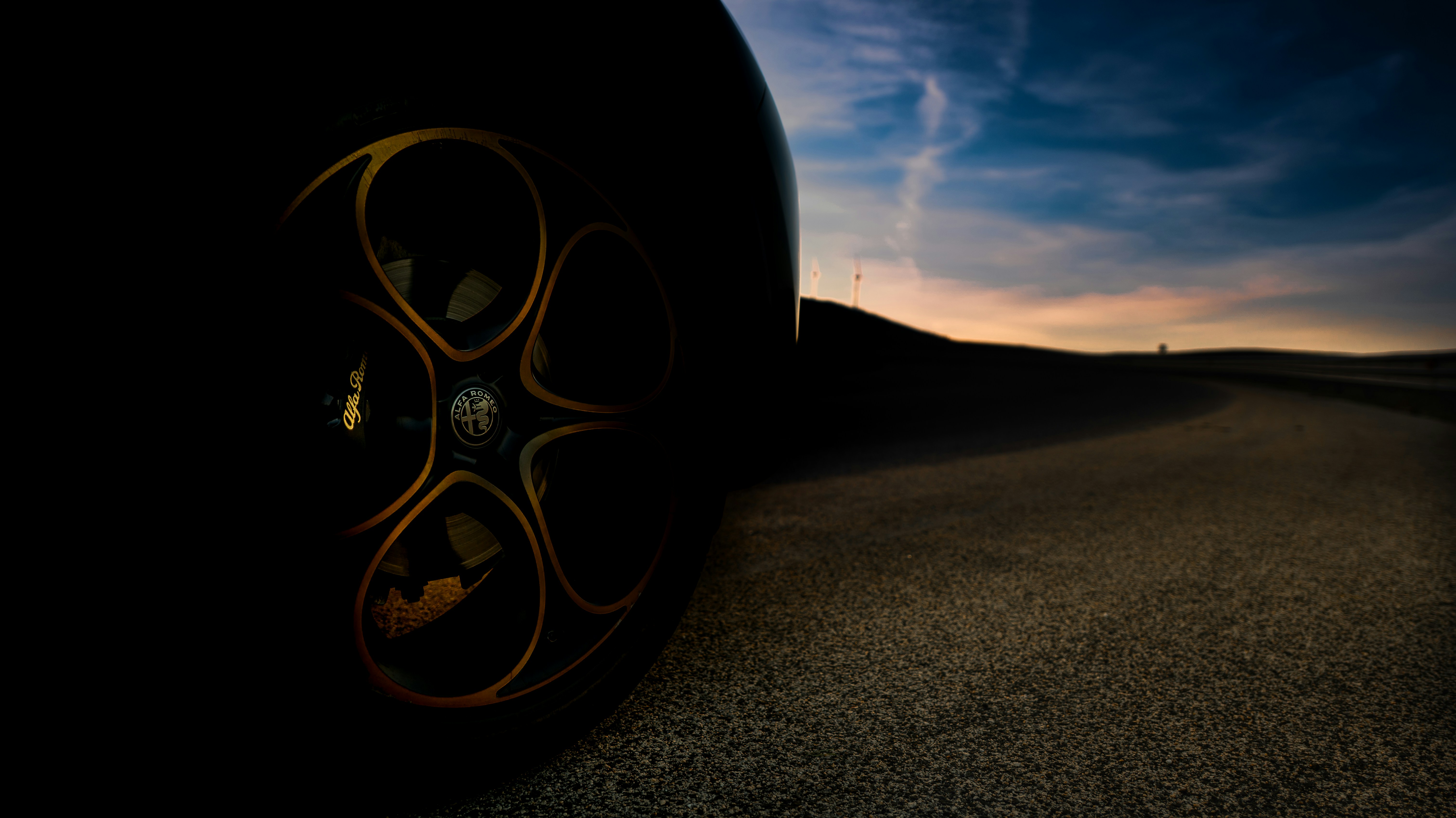 Low-Angle Night Drive: Rim and Road Meet the Sunset
