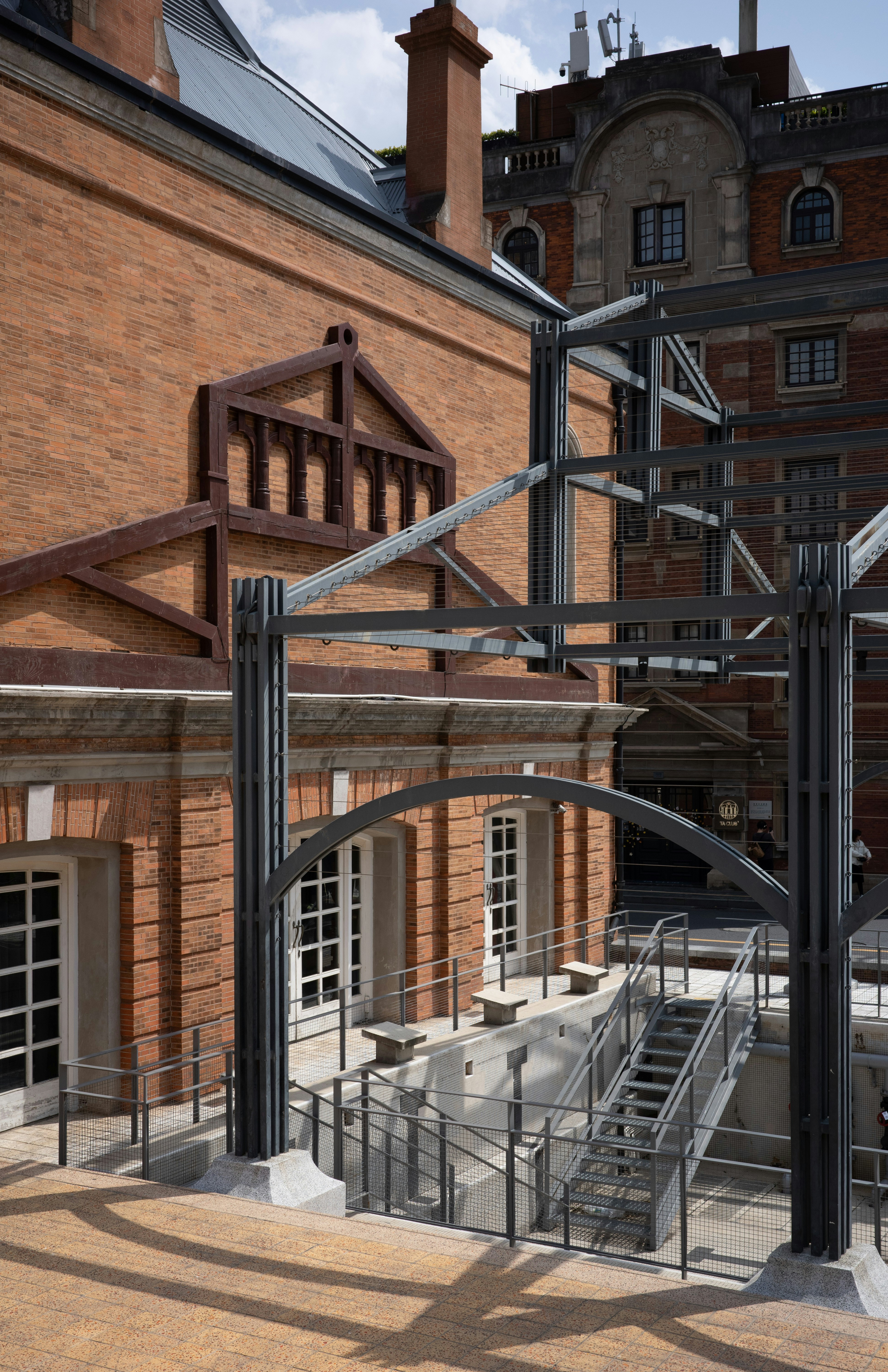 Industrial-Archway Vista: Steel girders framing a brick courtyard