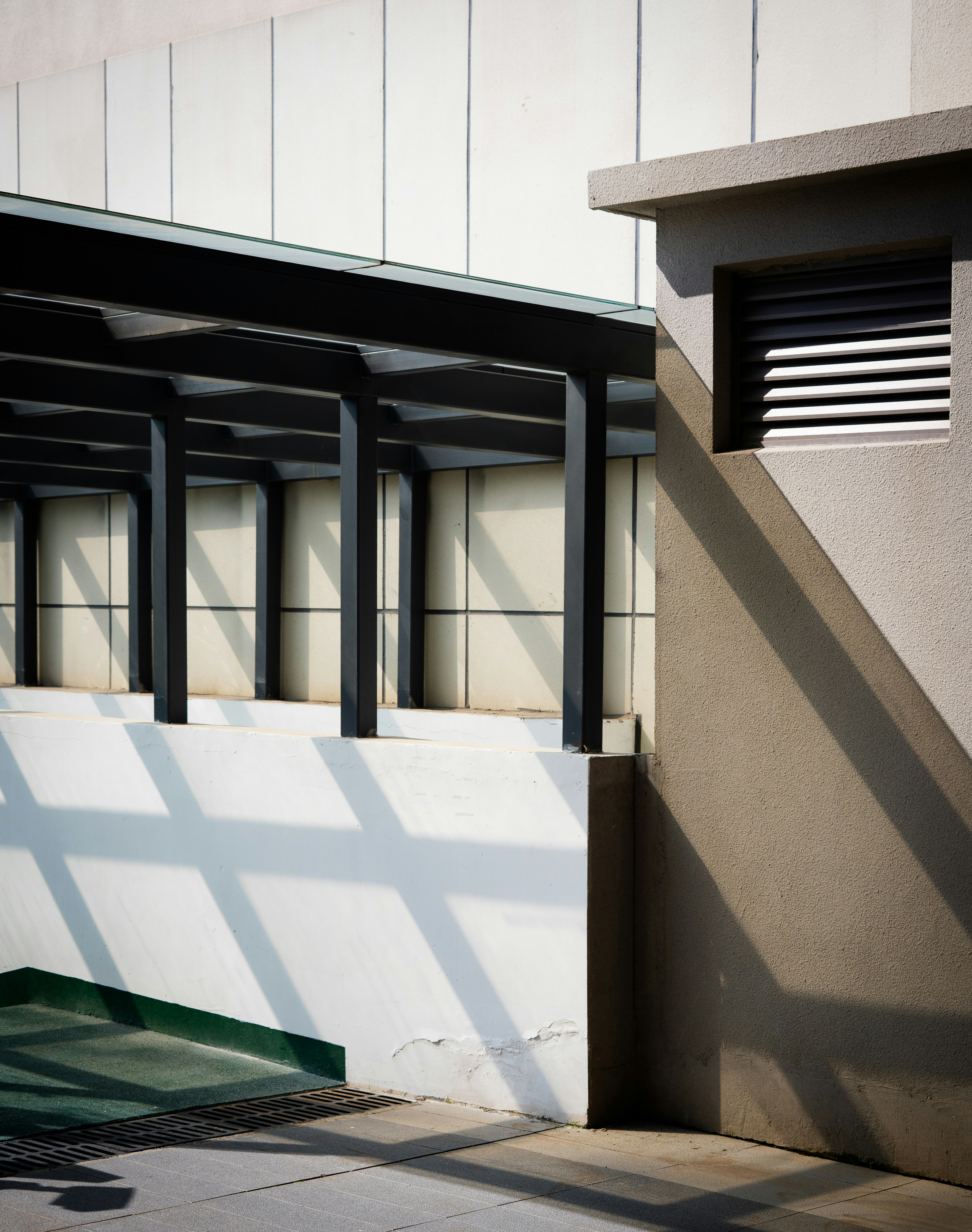 Shadowed Walkway: Geometry and Light Among Concrete Planes